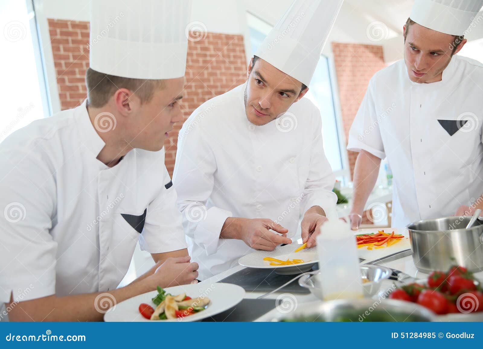 Cooking Apprentices with Chef Preparing Dishes Stock Image - Image of ...