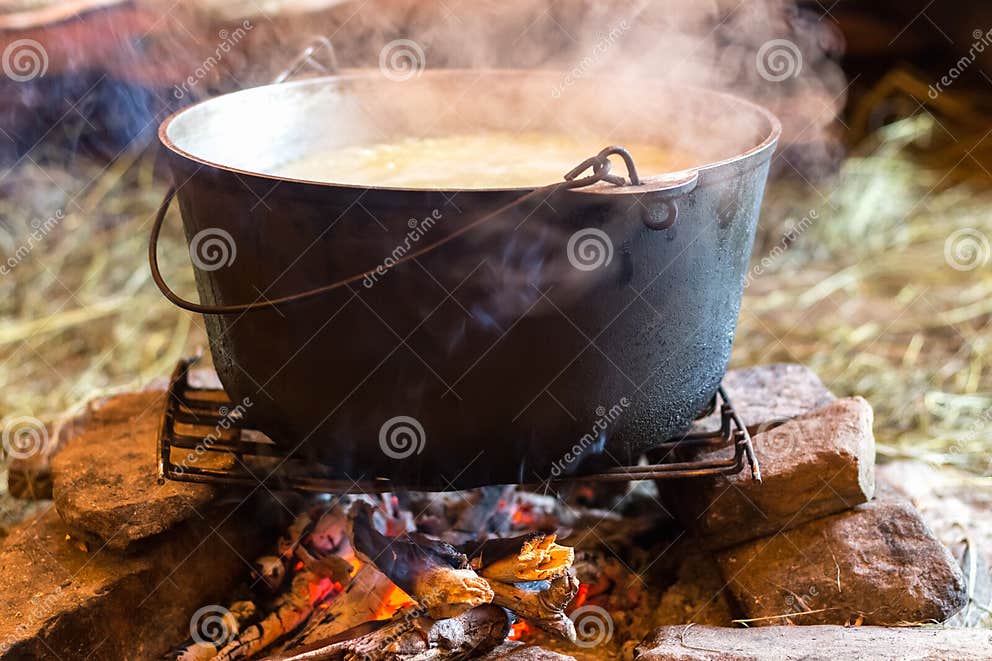 Cooking in a Cauldron on Fire Stock Image - Image of metal, cauldron ...