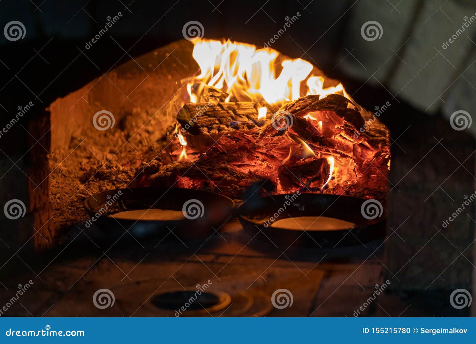 Cooking in the Fireplace. Pancakes in a Pan are Fried on a Fire in the ...