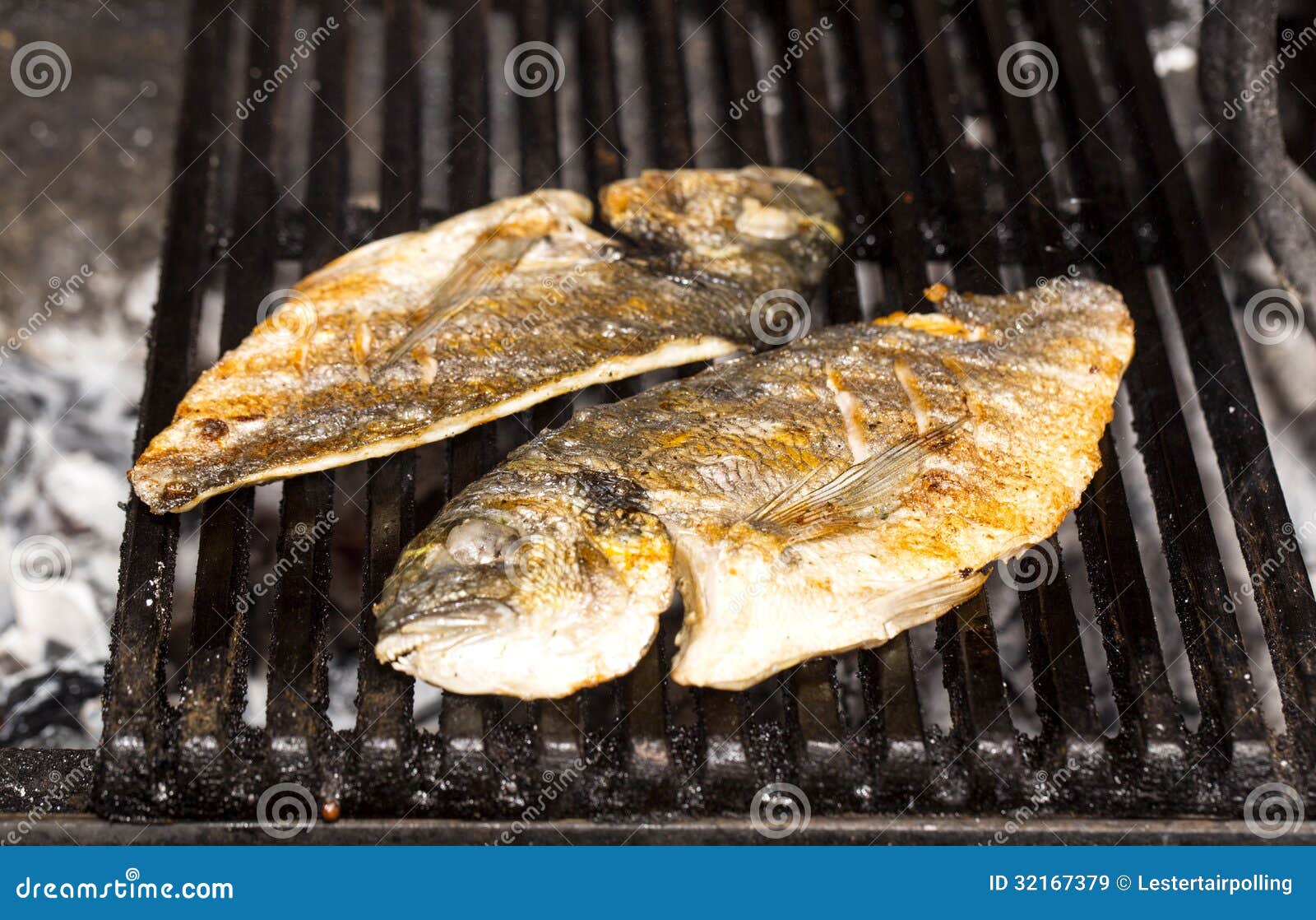 Cooking fish on the grill stock image. Image of party - 32167379