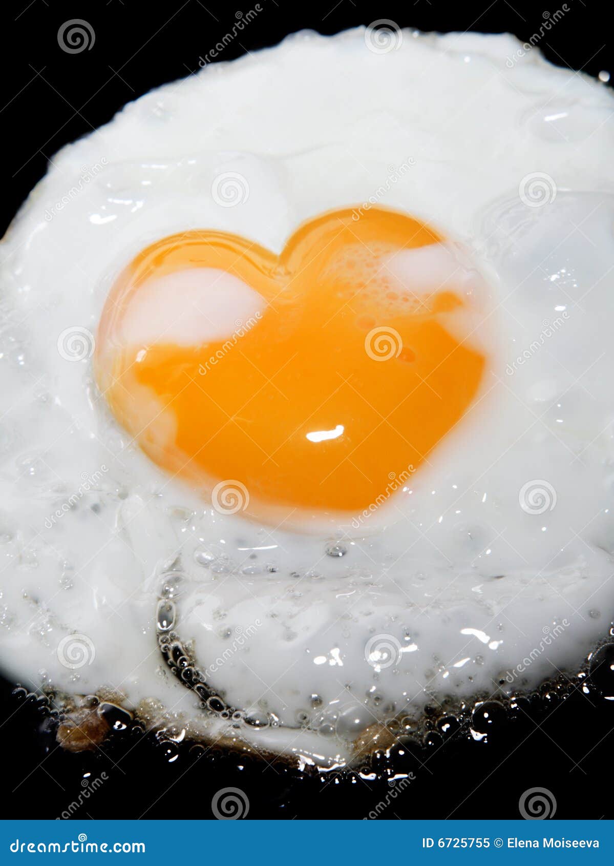 Cooking Frying Egg with Heart Shape Yolk on Black Stock Image - Image ...