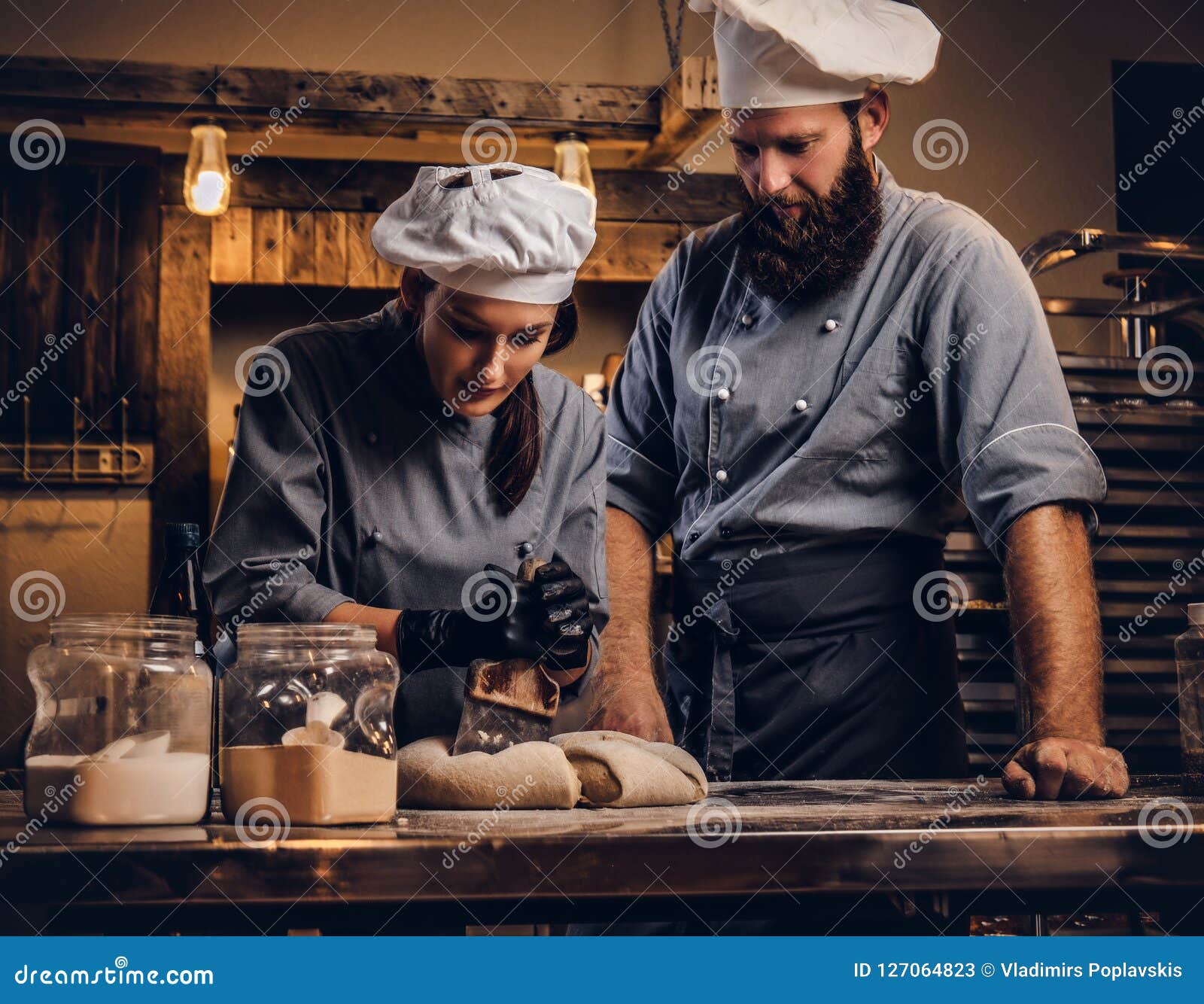 Chef Teaching His Assistant To Bake the Bread in a Bakery. Stock Image ...
