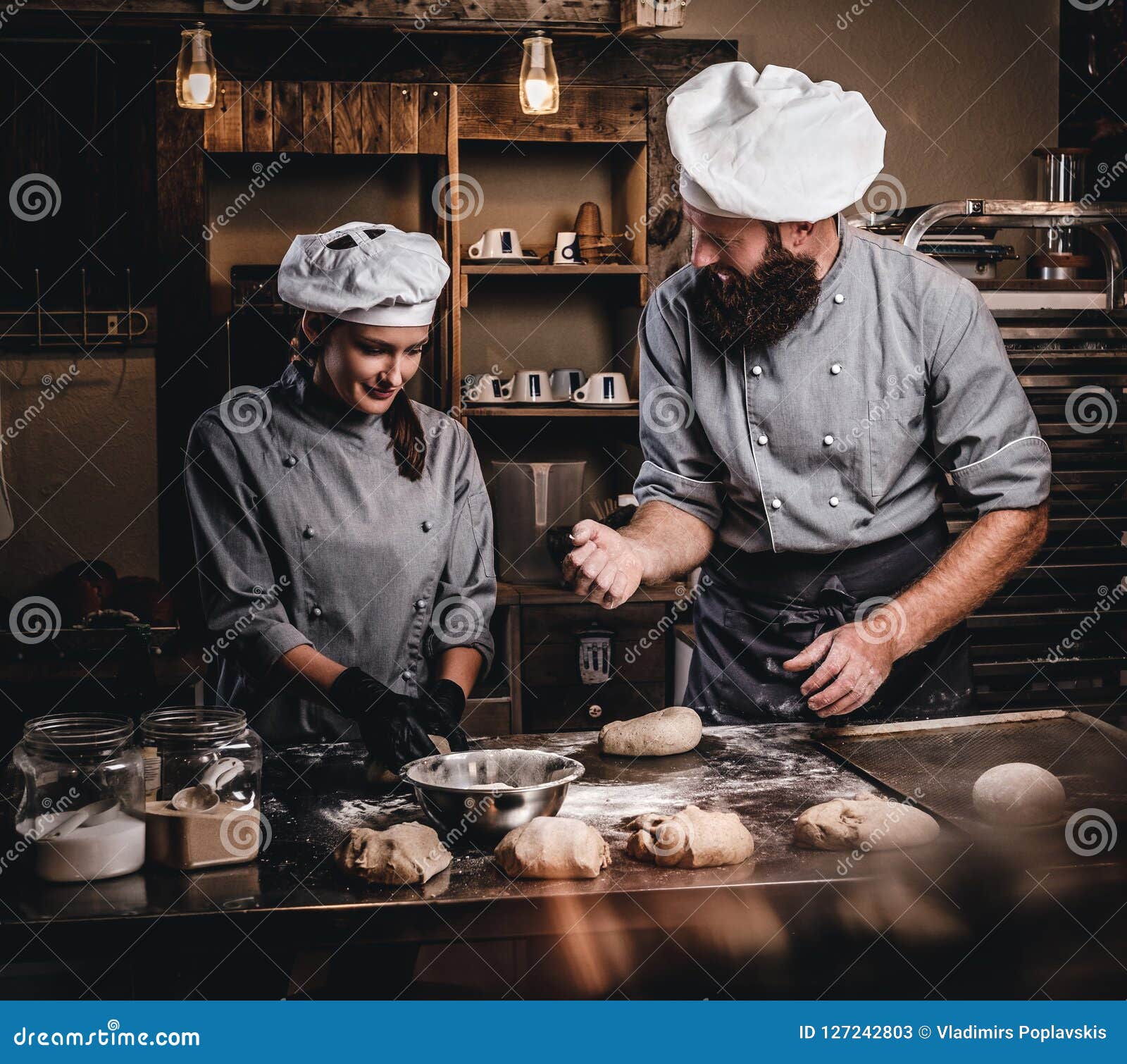 Chef Teaching His Assistant To Bake the Bread in a Bakery. Stock Image ...