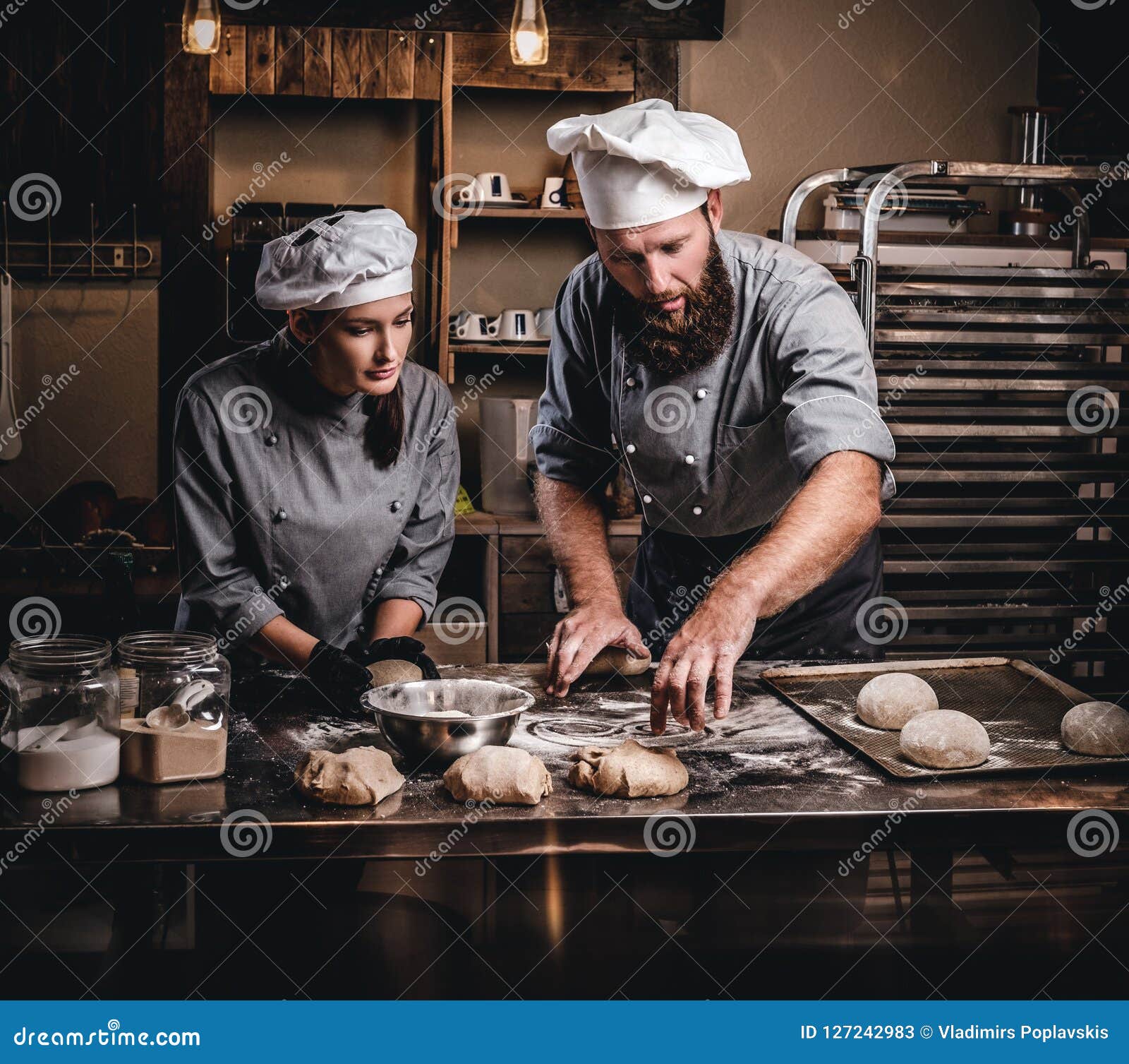Chef Teaching His Assistant To Bake the Bread in a Bakery. Stock Image ...