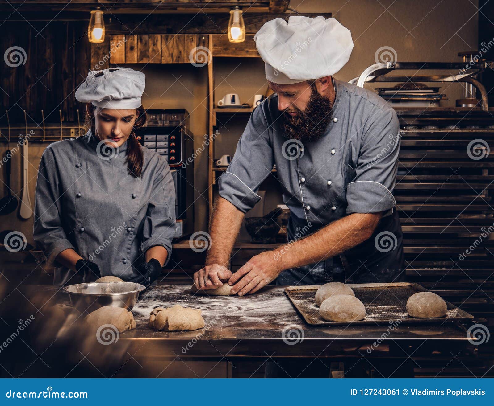Chef Teaching His Assistant To Bake the Bread in a Bakery. Stock Image ...