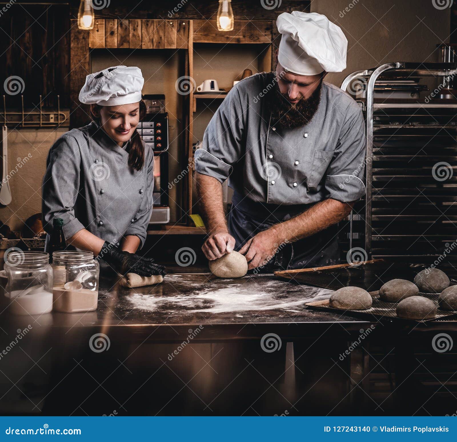 Chef Teaching His Assistant To Bake the Bread in a Bakery. Stock Photo ...