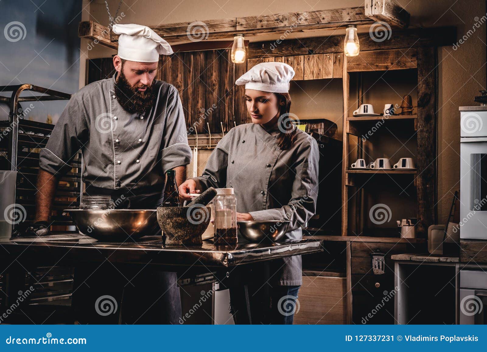 Chef Teaching His Assistant To Bake the Bread in the Bakery. Stock ...