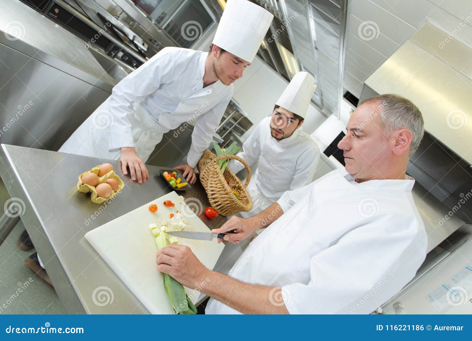 Cooking Lesson with Two Apprentices Stock Photo - Image of vertical ...