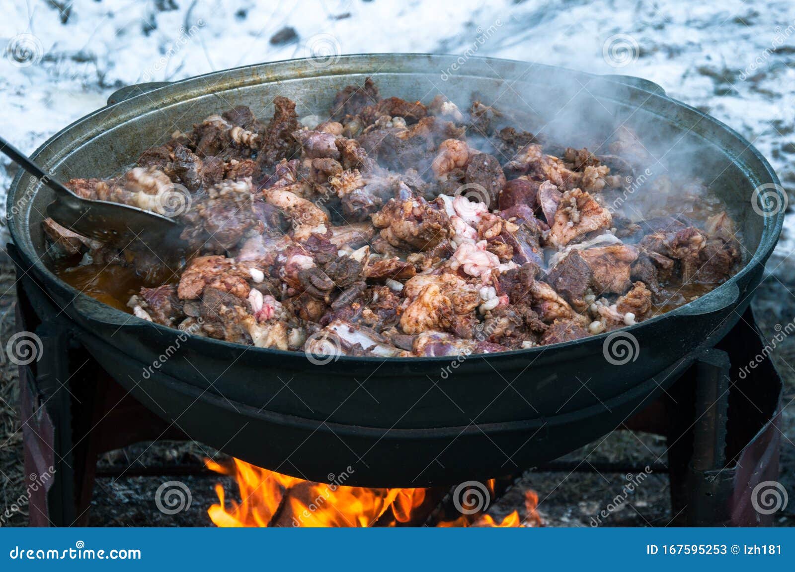 Cooking Meat on Fire in a Large Cauldron. a Traditional Dish Stock ...