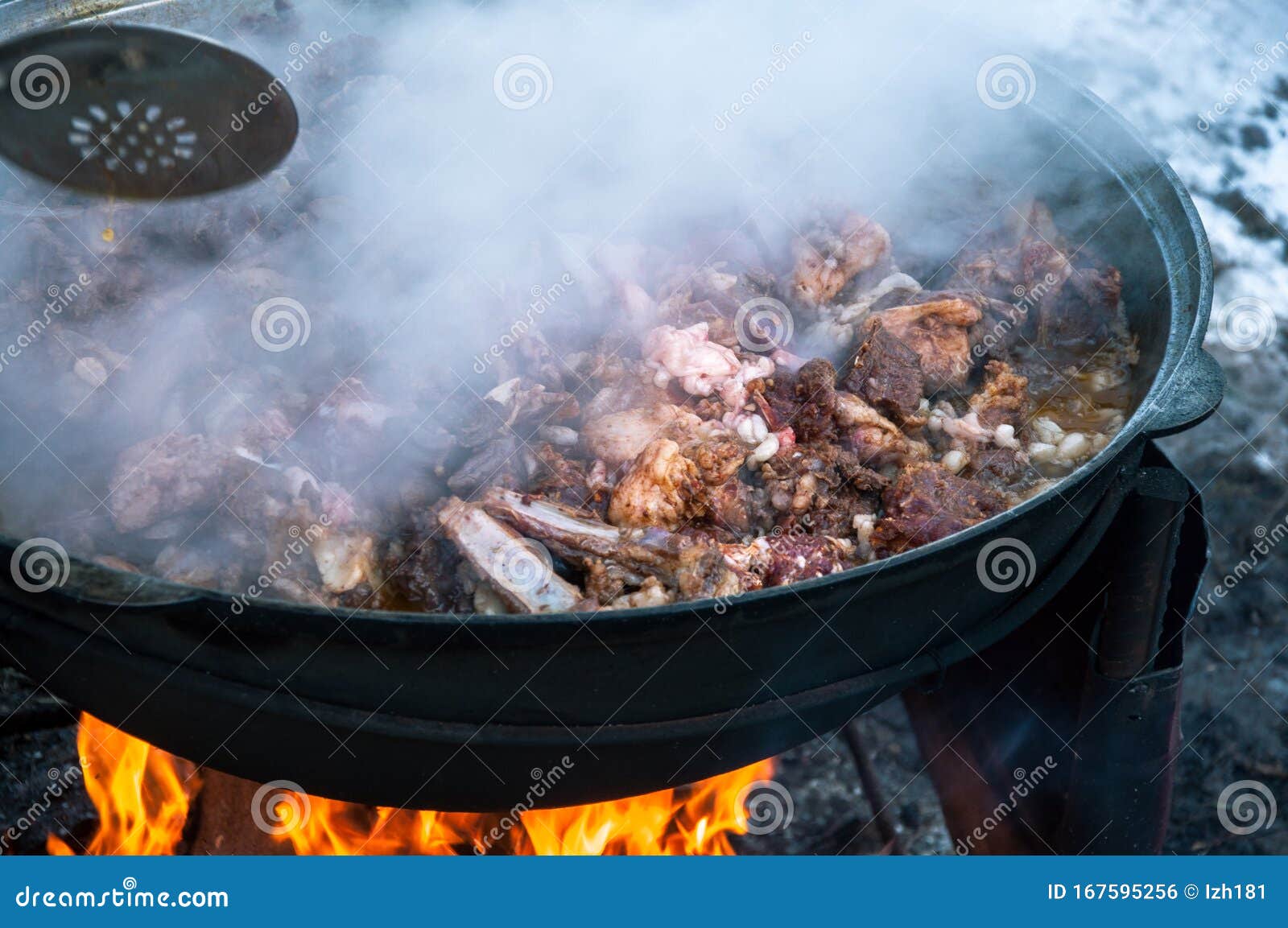 Cooking Meat on Fire in a Large Cauldron. a Traditional Dish Stock ...
