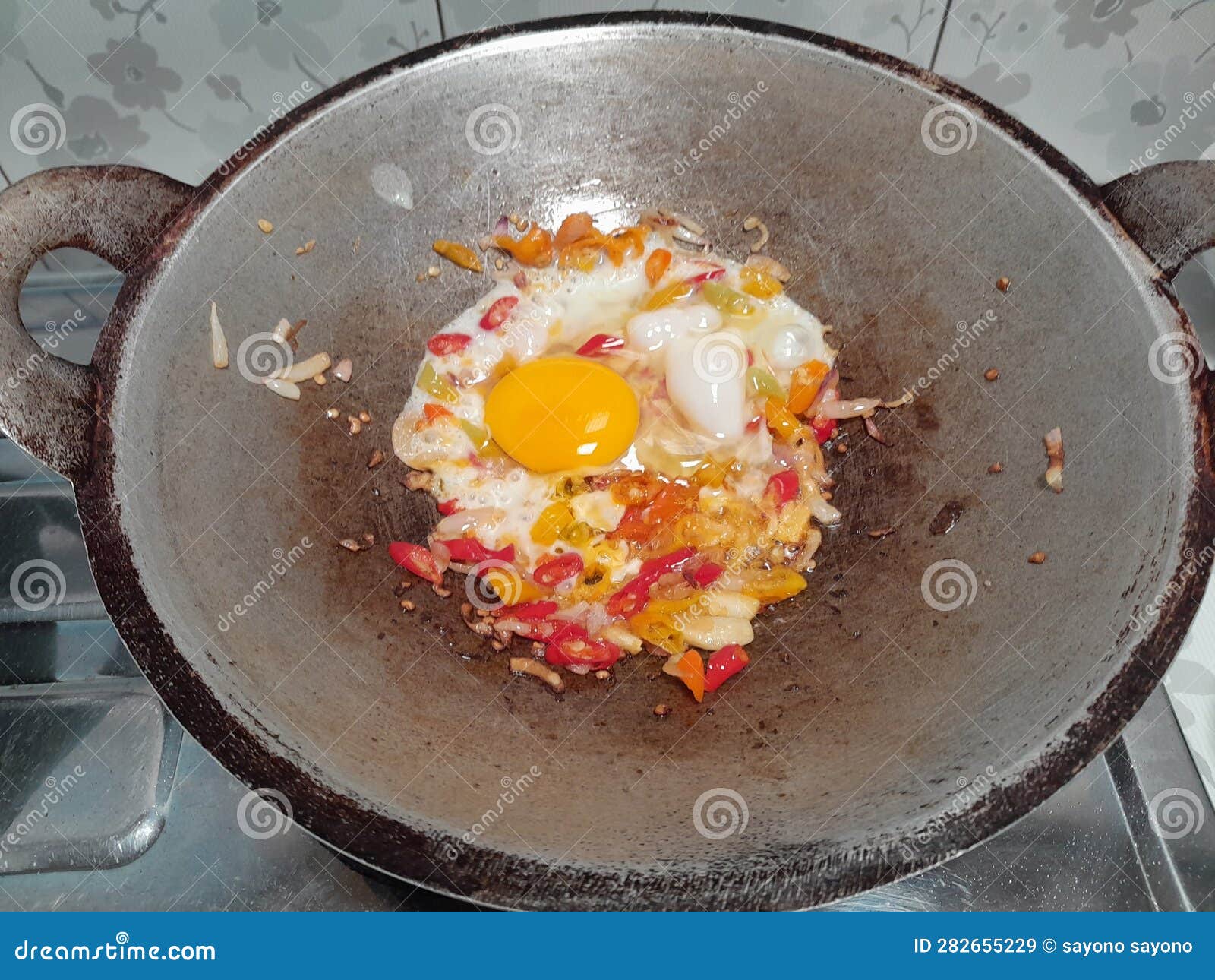 Cooking on a Pan Scrambled Eggs and a Mixture of Spices that Have Been ...