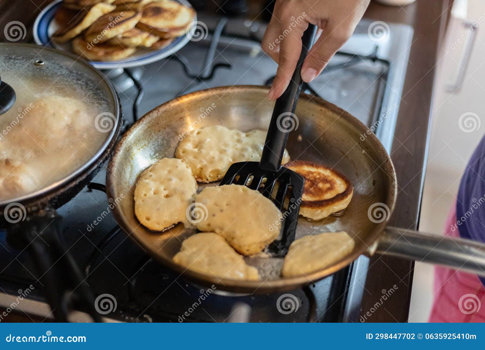 Cooking pancakes close-up stock photo. Image of baking - 298447702