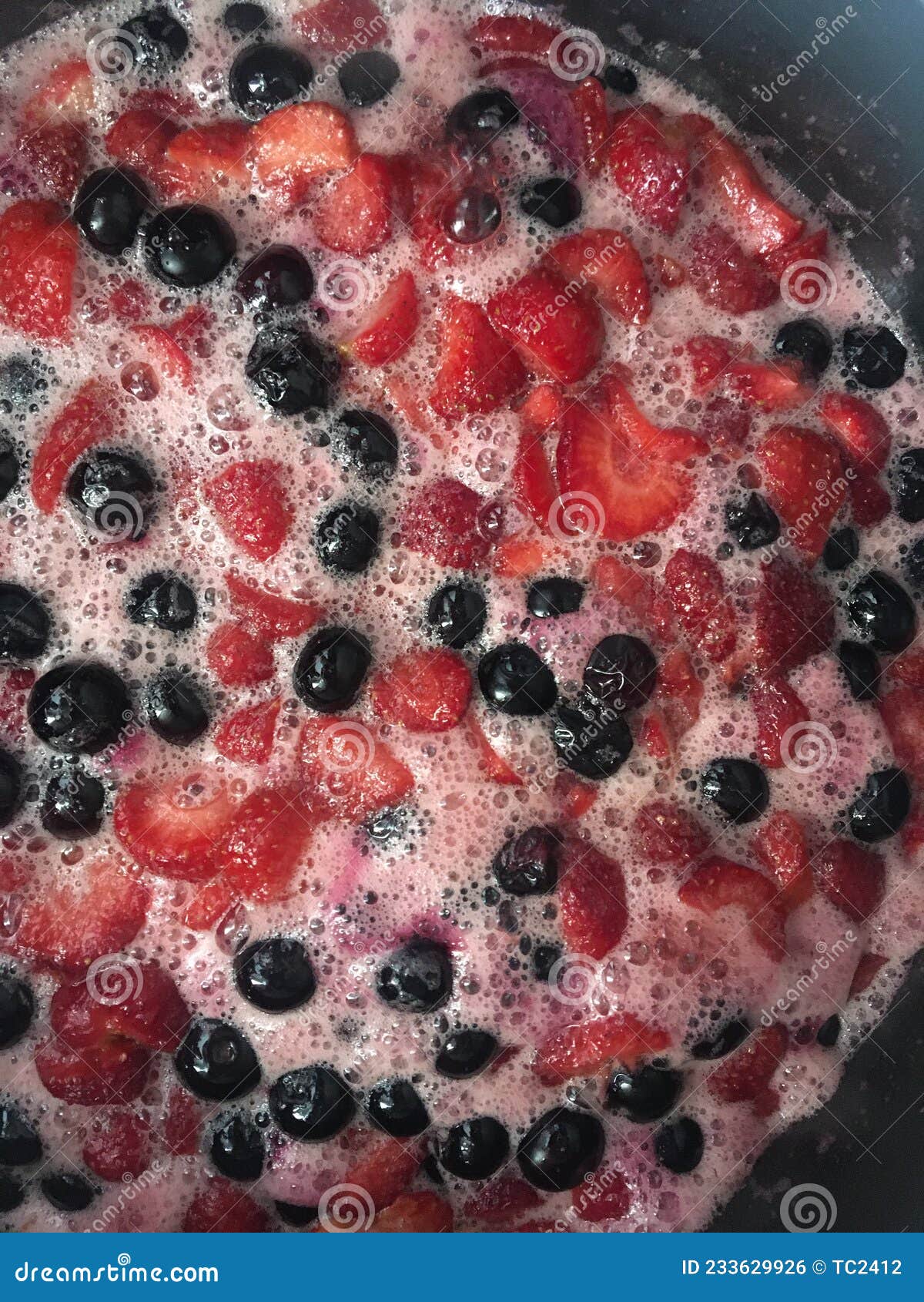 Cooking a red fruit jam stock photo. Image of natural - 233629926