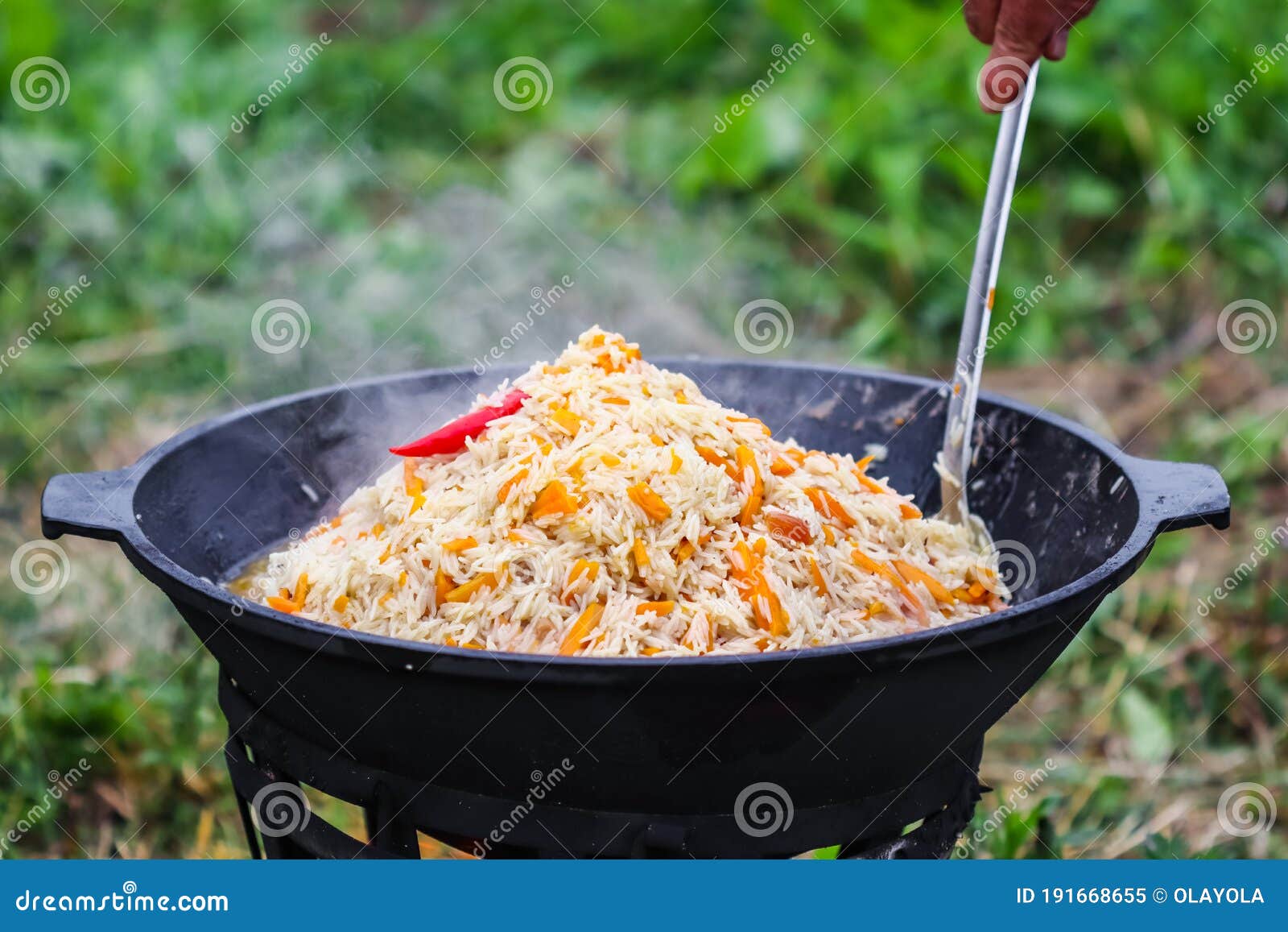Cooking Rice Pilaf in a Large Cast-iron Pot on Fire Stock Image - Image ...
