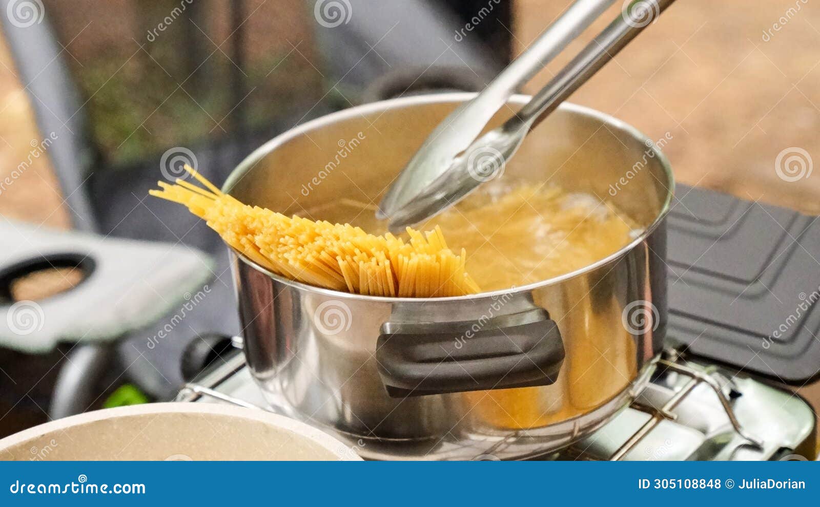 Cooking Spaghetti Outside in Forest Camping. Summer Outdoors Activities ...