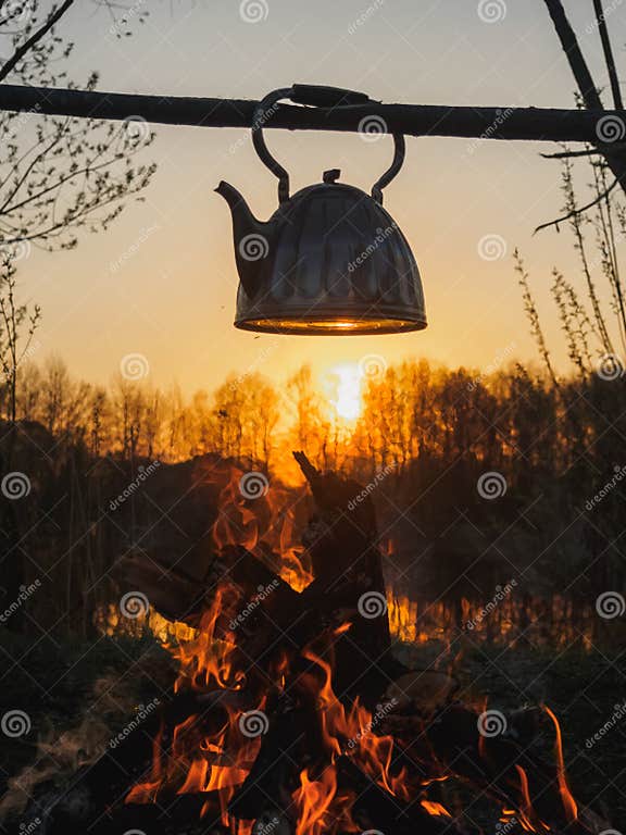 Cooking Tea on a Fire in a Kettle at Sunset Stock Photo - Image of ...