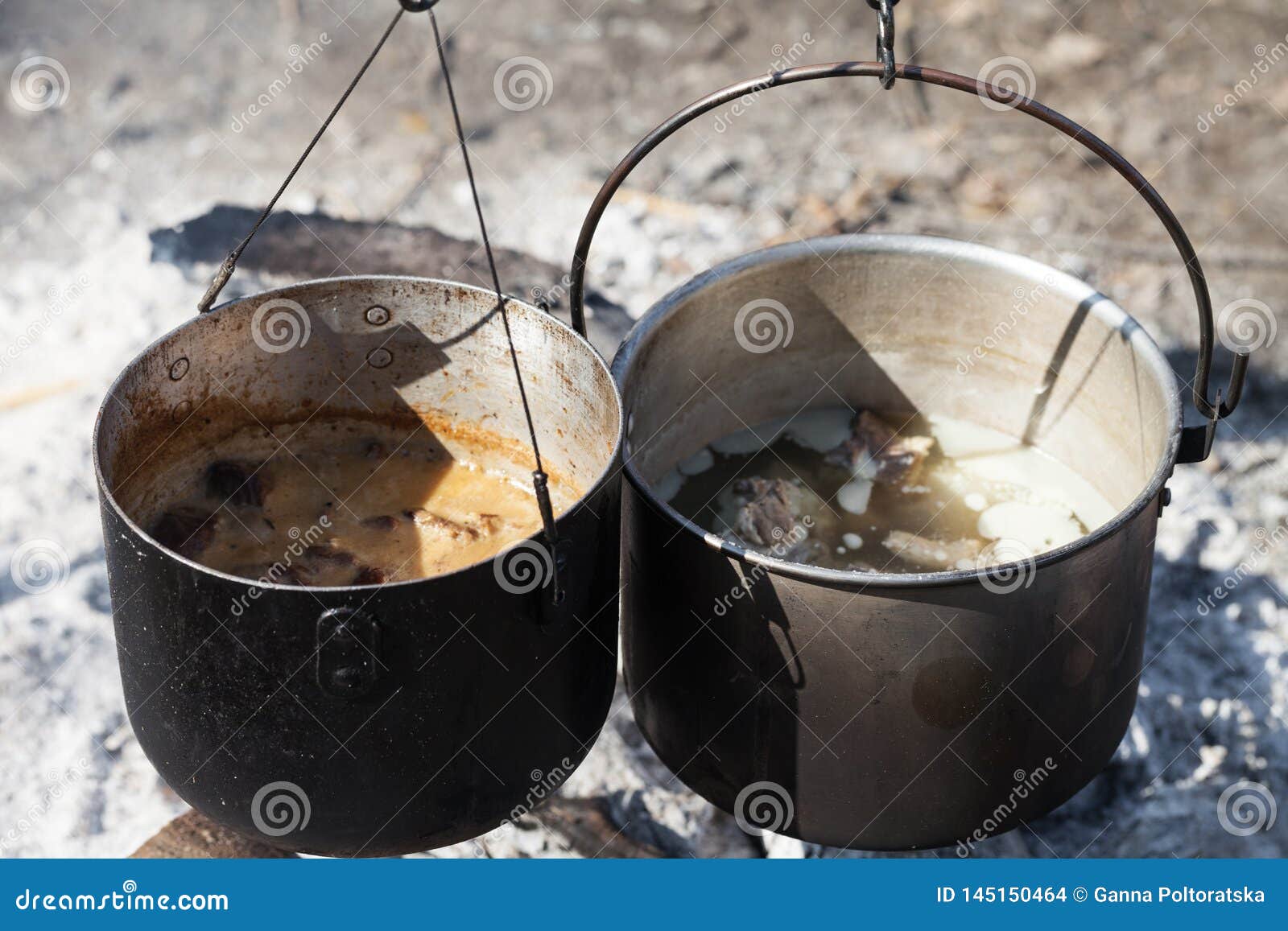 Cooking in Two Sooty Old Cauldrons on Campfire Stock Photo - Image of ...