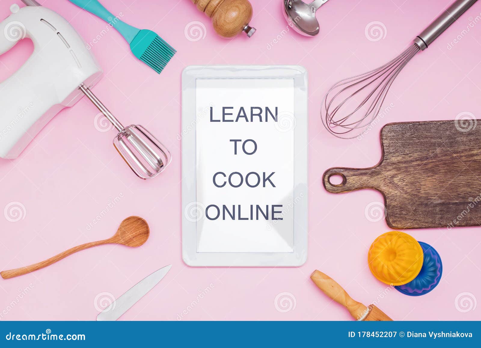 Cooking Utensils and Kithchenware on Pink Table and Tablet with Text ...