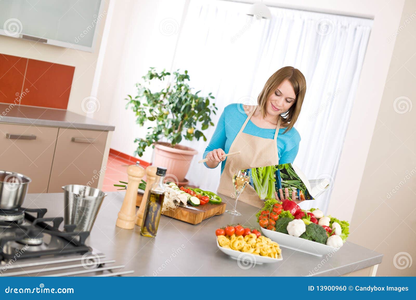 Cooking - Woman Reading Cookbook in Kitchen Stock Photo - Image of ...
