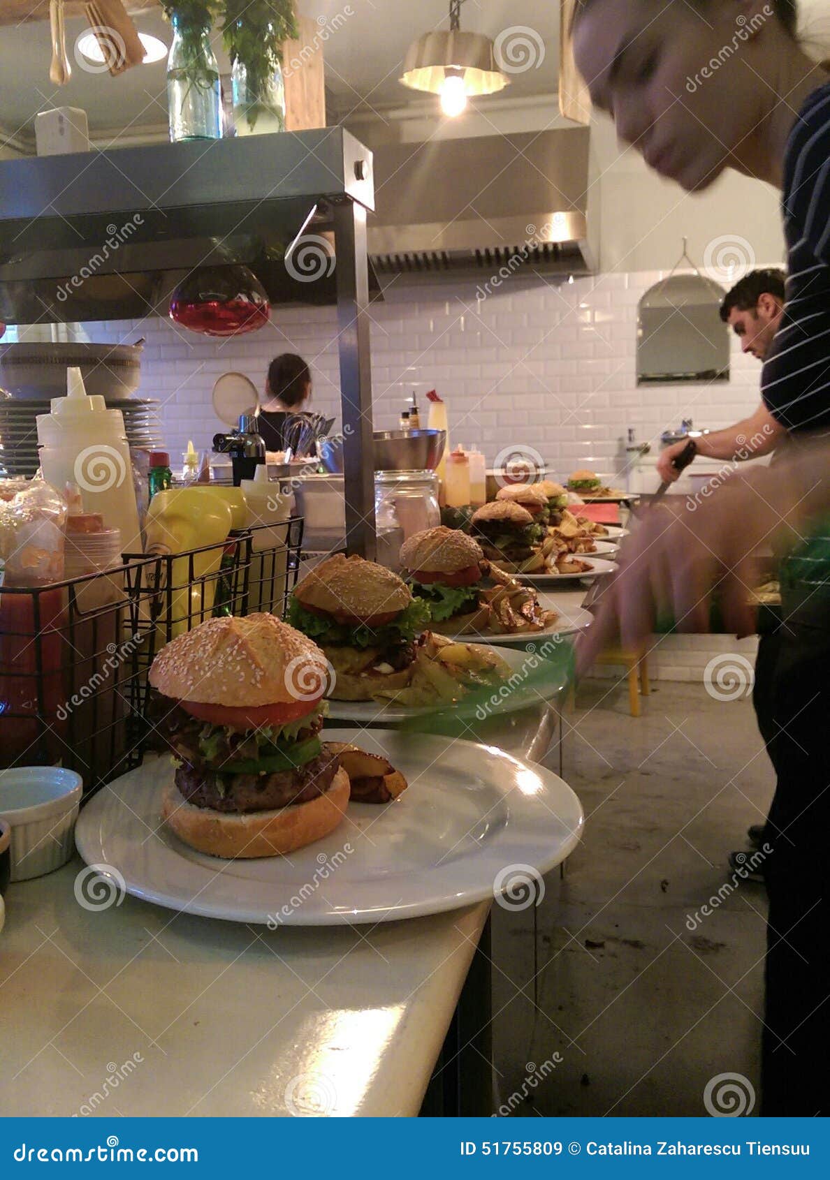 Cooks Preparing Burgers in a Restaurant Kitchen Editorial Stock Image ...