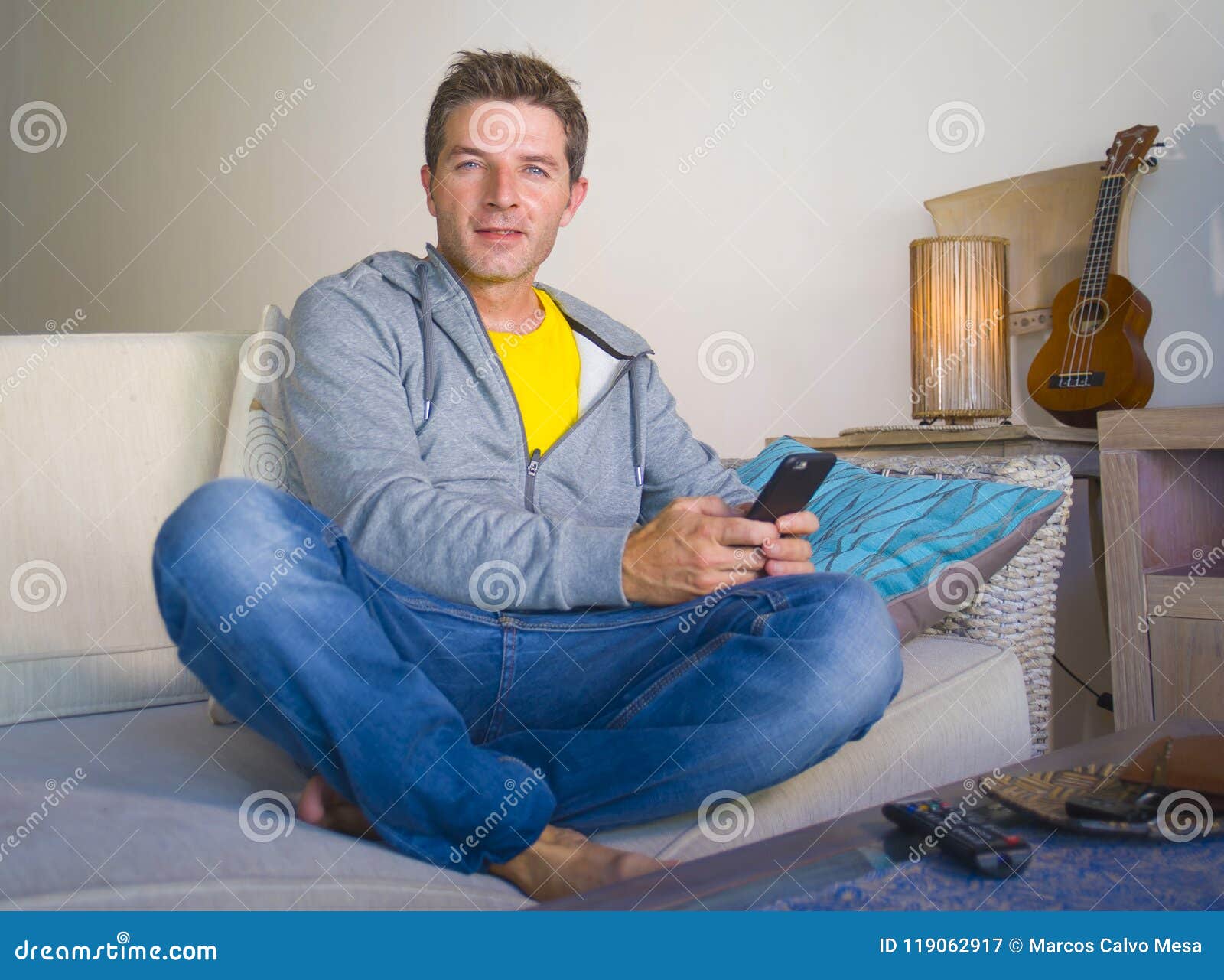 Cool Attractive And Happy Man Sitting At Living Room Sofa Couch