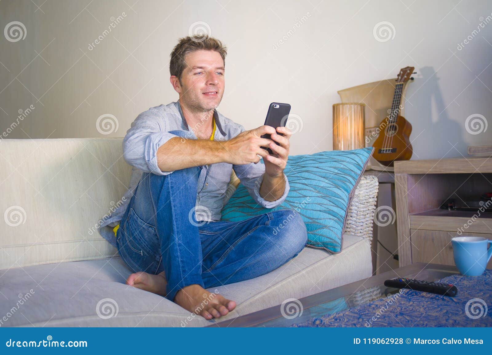 Cool Attractive And Happy Man Sitting At Living Room Sofa Couch