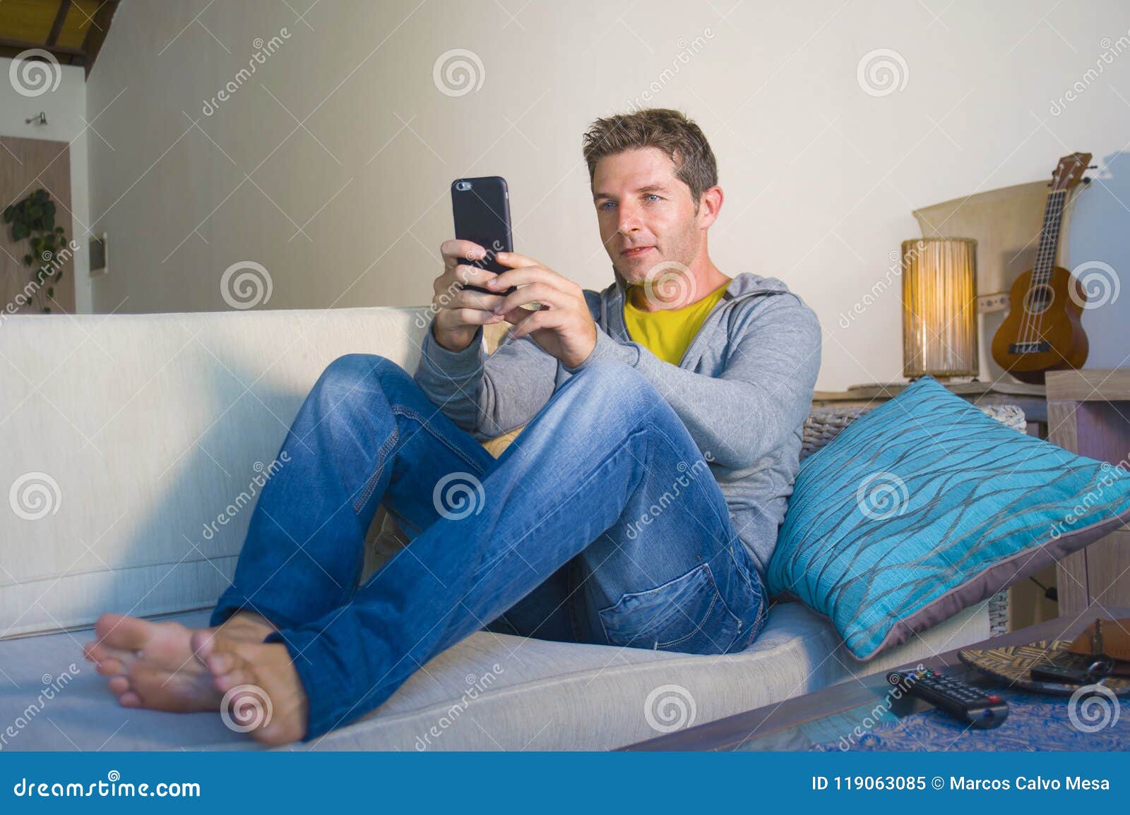 Cool Attractive And Happy Man Sitting At Living Room Sofa Couch