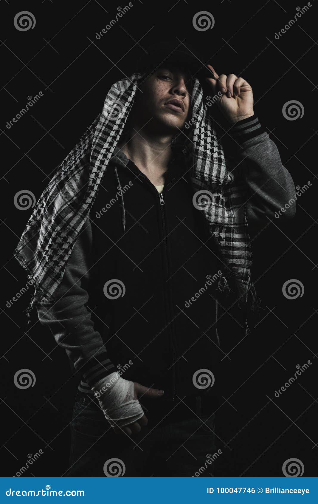Cool Boy in Hip-hop Style Put Cap on Head with Lowered Scarf Stock ...