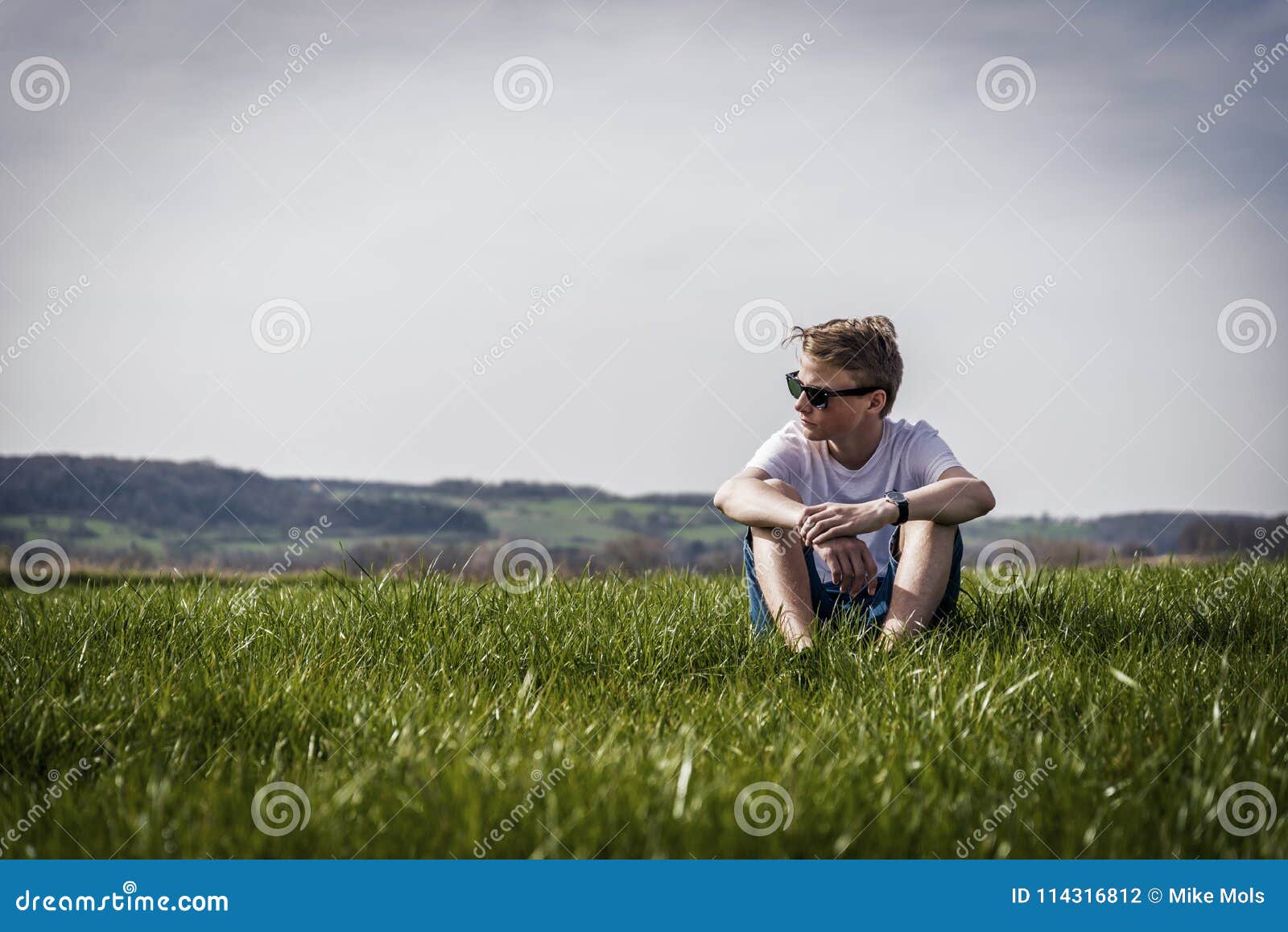 Cool Dude Sitting in a Field Stock Photo - Image of field, teenage ...