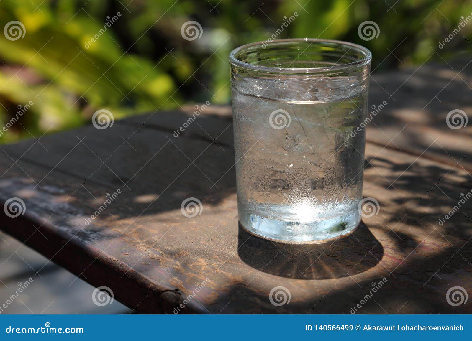 Cool Glass of Water with Droplet on Rustic Wooden Table with Strong ...