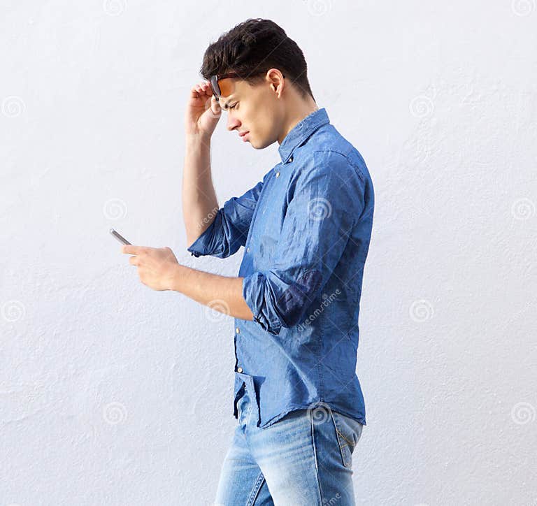Cool Guy Walking and Looking at Mobile Phone Stock Image - Image of ...