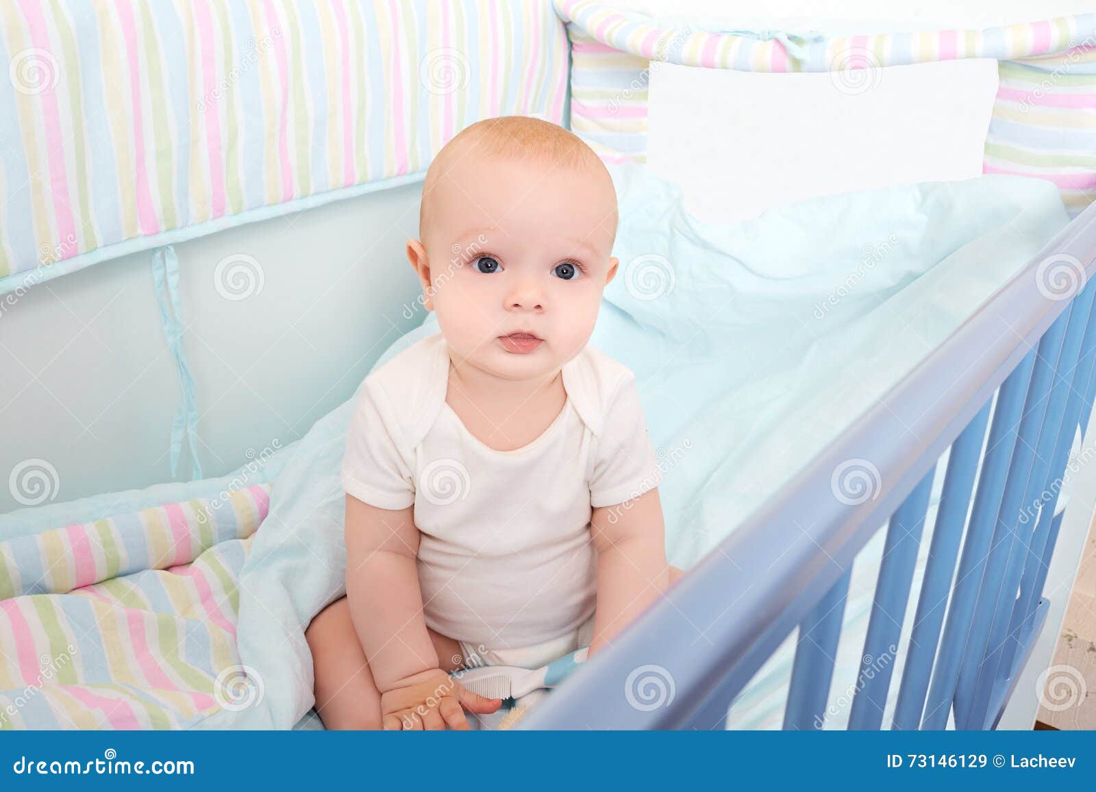 Cool Kid Sitting in Baby Bed and Looks. Stock Image - Image of hand ...