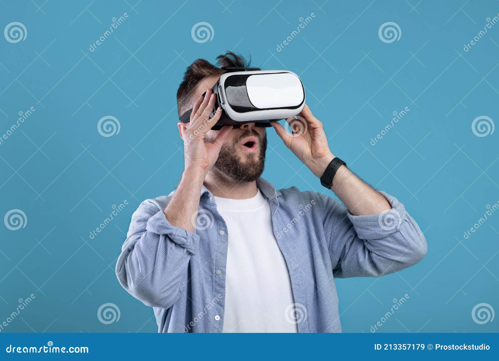 Cool Millennial Guy Experiencing Virtual Reality in VR Headset on Blue ...