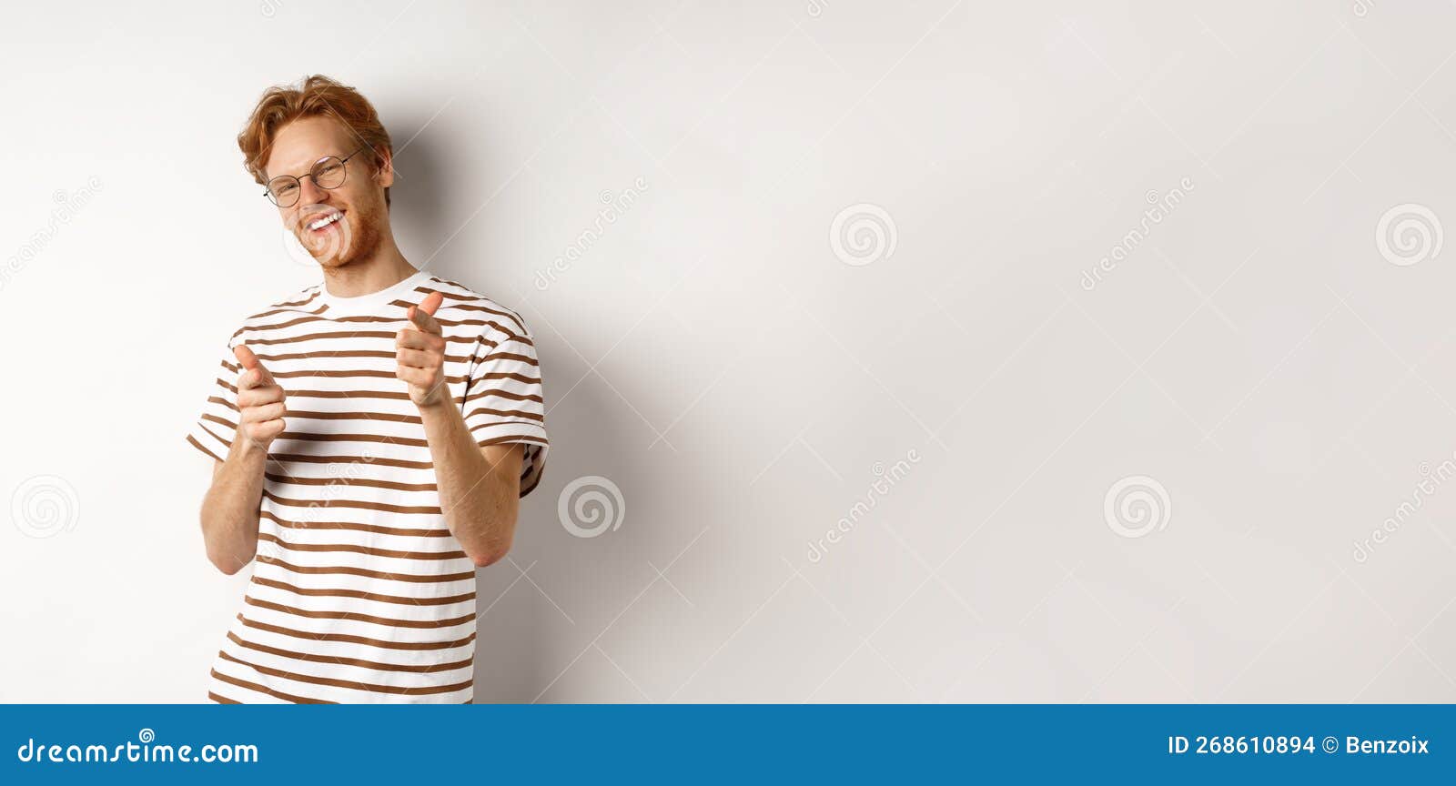 Cool And Sassy Redhead Man With Beard And Glasses Pointing Finger
