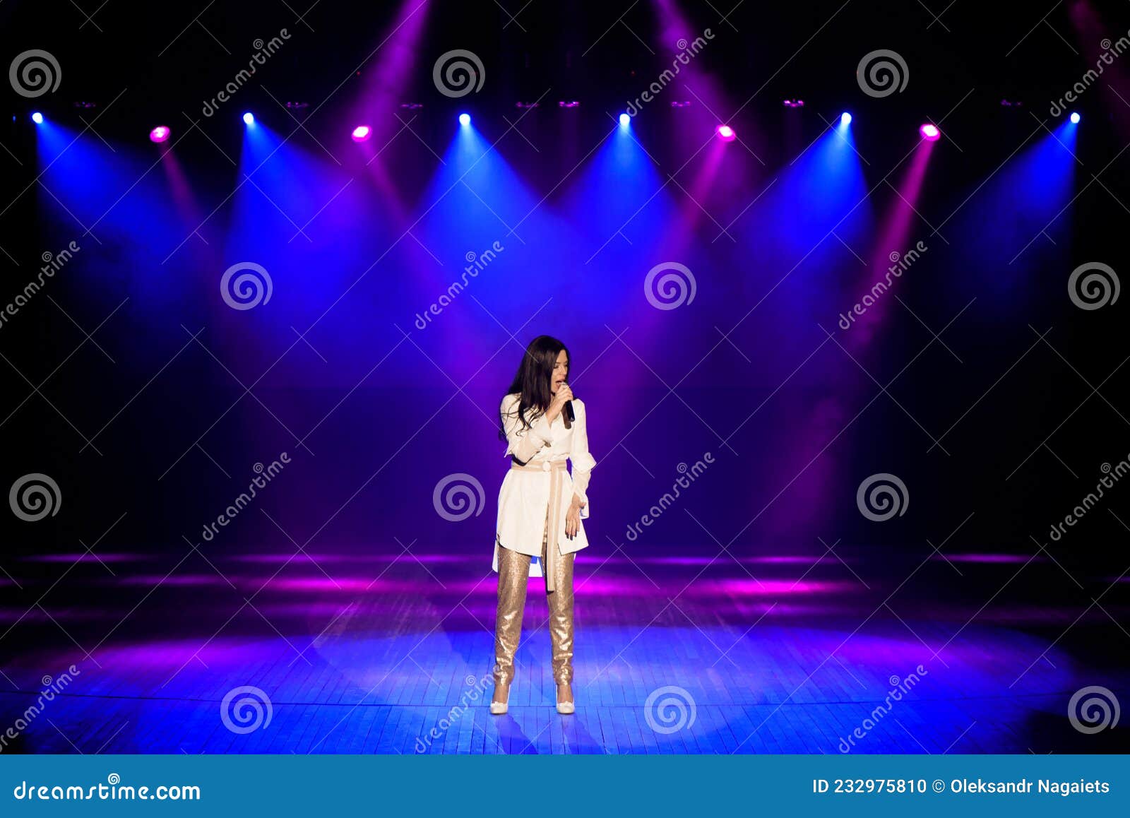 Cool Singer with Microphone on Bright Backlit Stage in Bright Blue ...
