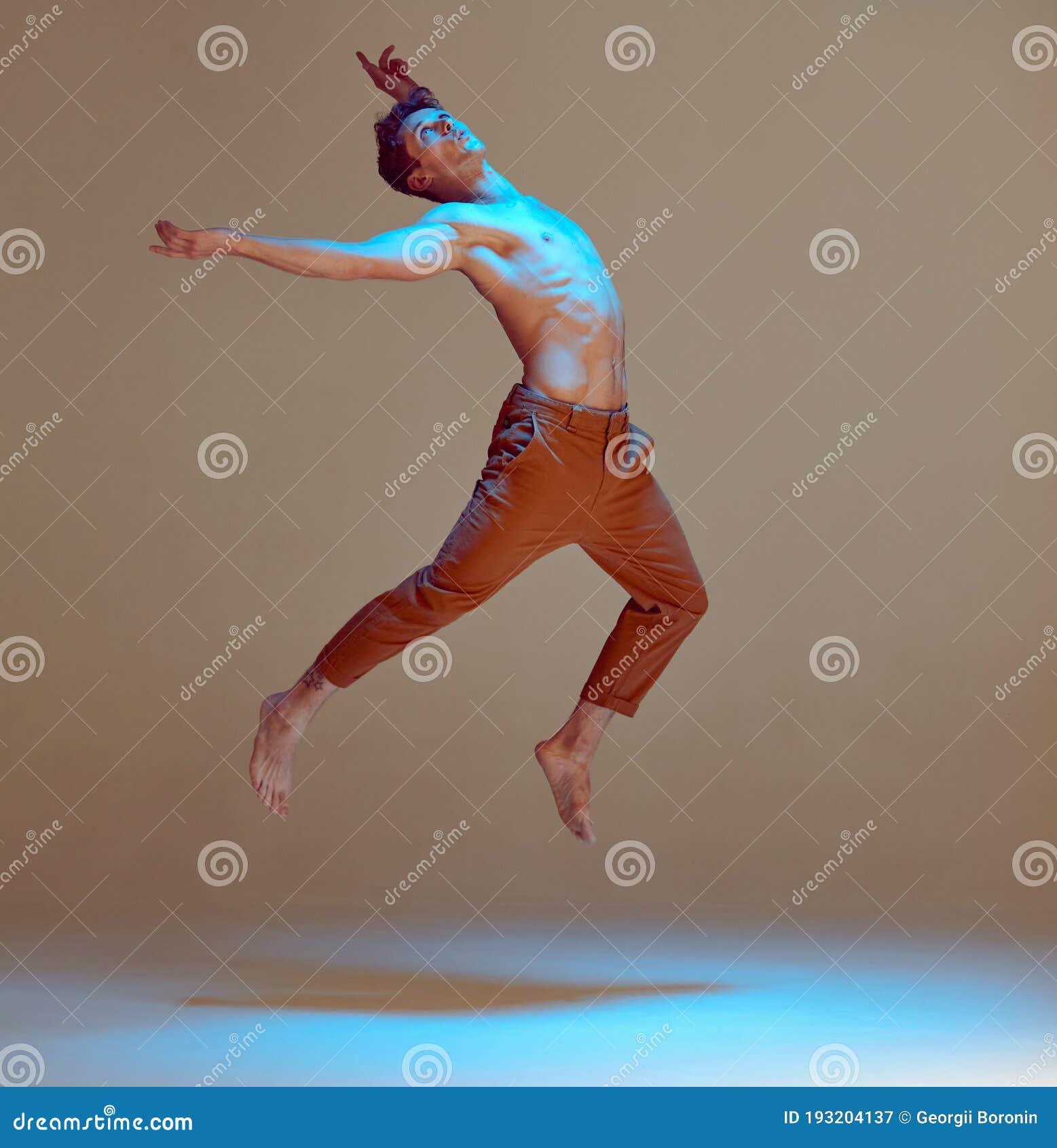 Cool Young Guy Dancing and Floating in a Jump in Neon Light. Dance ...