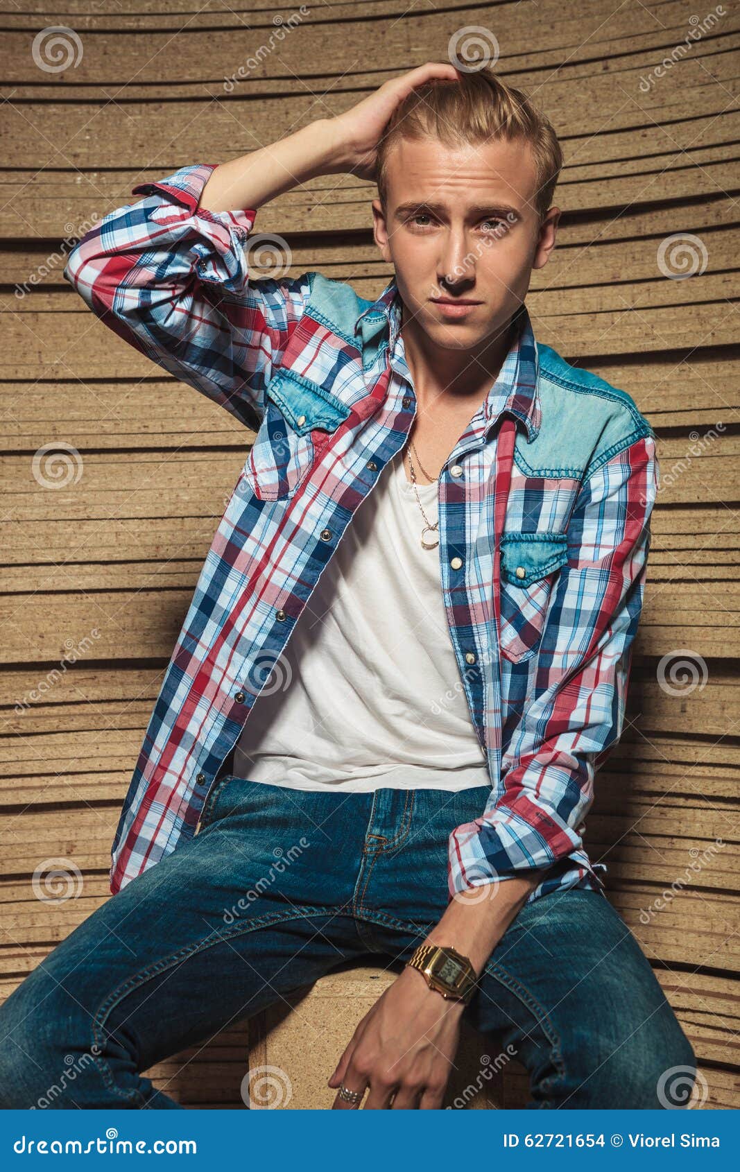 Cool Young Man Sitting while Fixing His Hair Stock Photo - Image of ...