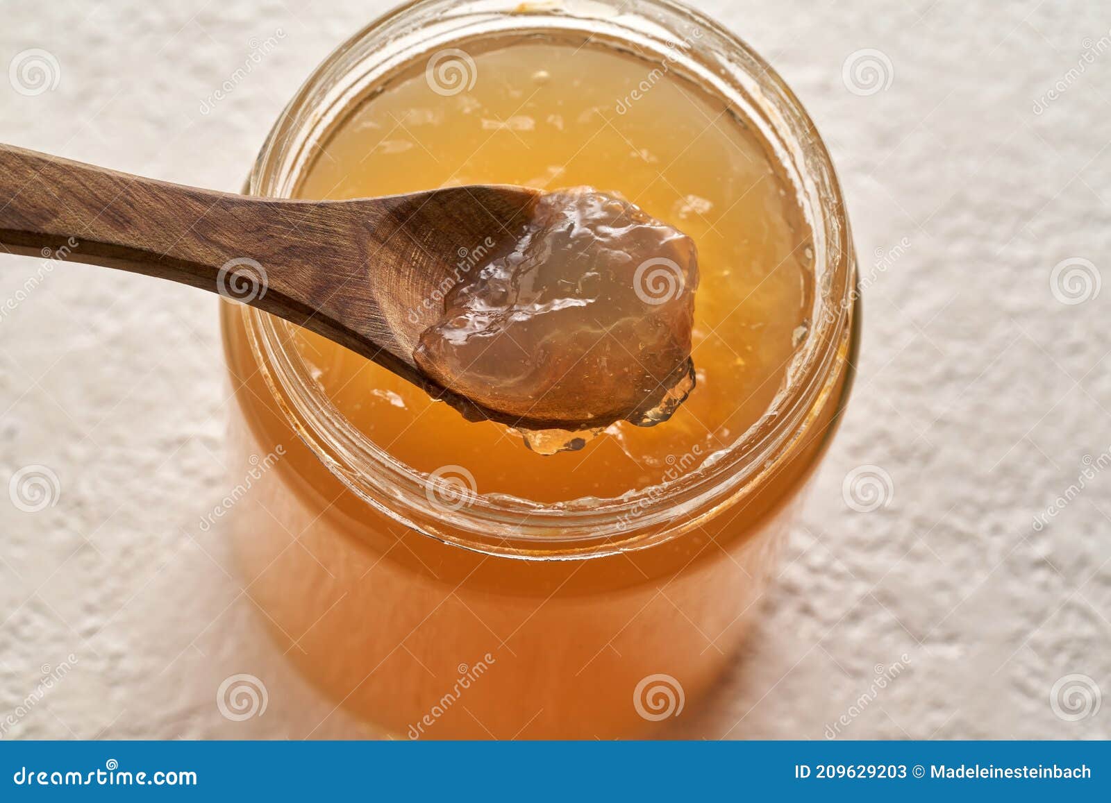 Cooled Down Congealed Beef Bone Broth on a Spoon and in a Glass Jar on ...