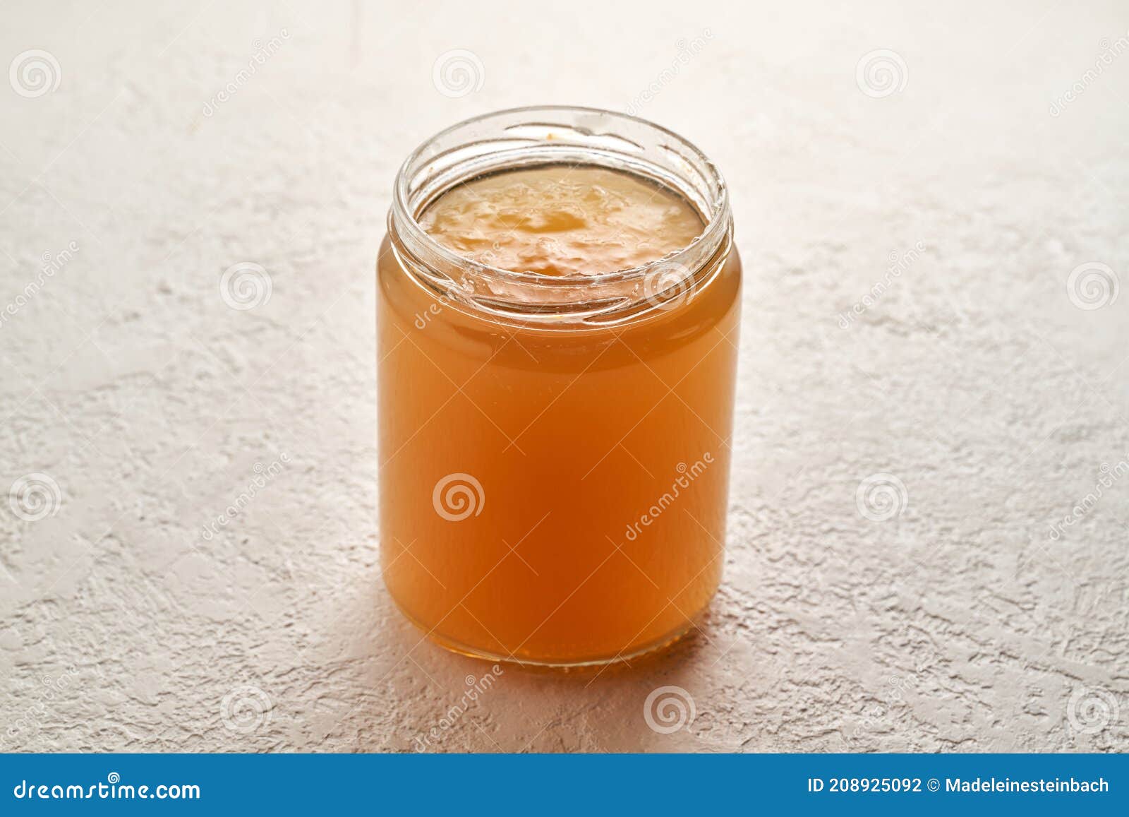 Cooled Down Congealed Beef Bone Broth On A Spoon And In A Glass Jar On ...