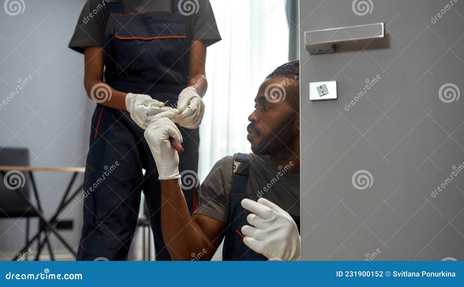 Cooperation and Teamwork Concept. Locksmith and Apprentice in ...