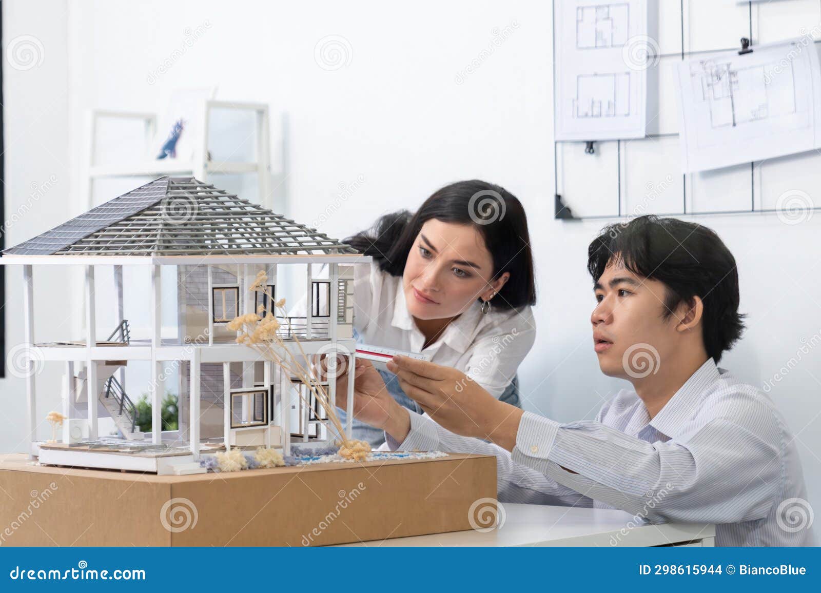 Cooperative Engineer Team Working Together To Measure House Model ...