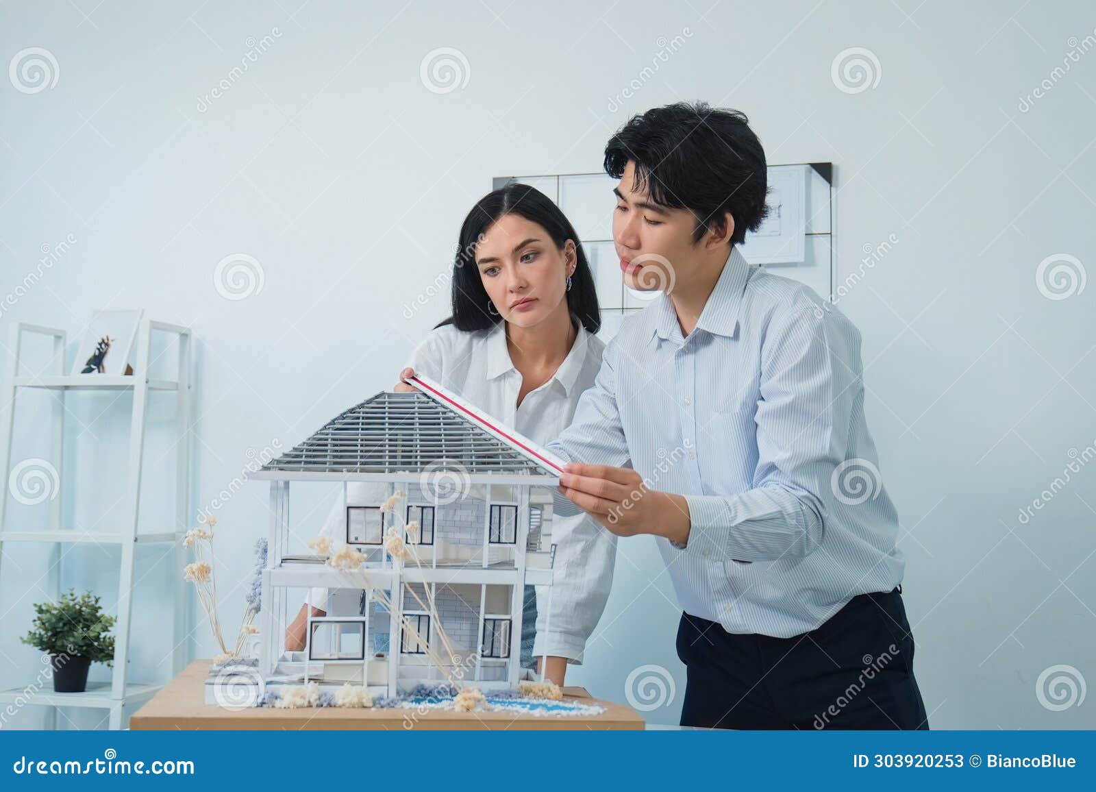 Cooperative Engineer Team Working Together To Measure House Model ...