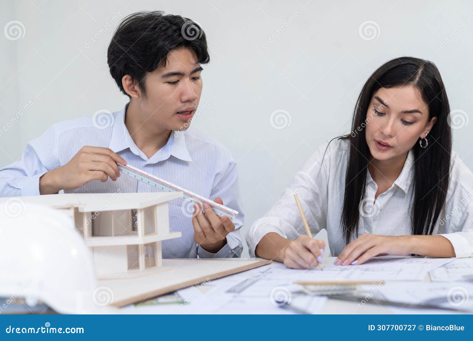 Cooperative Engineer Team Working Together To Measure House Model ...