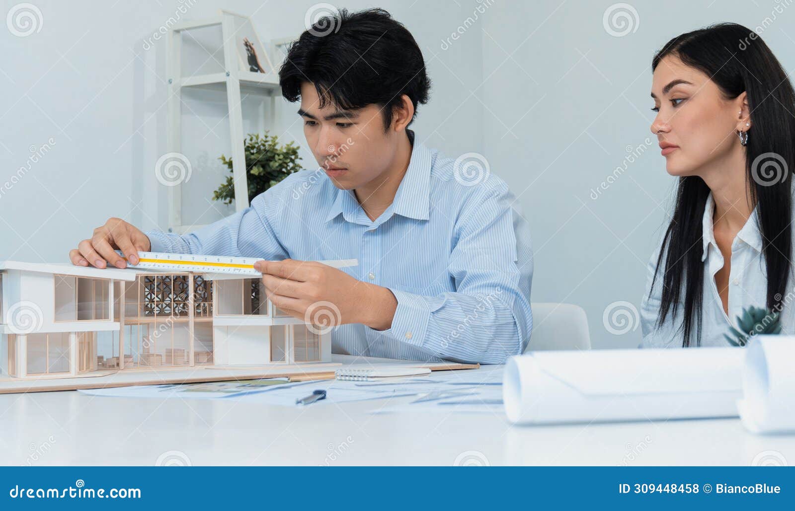 Cooperative Engineer Team Working Together To Measure House Model ...