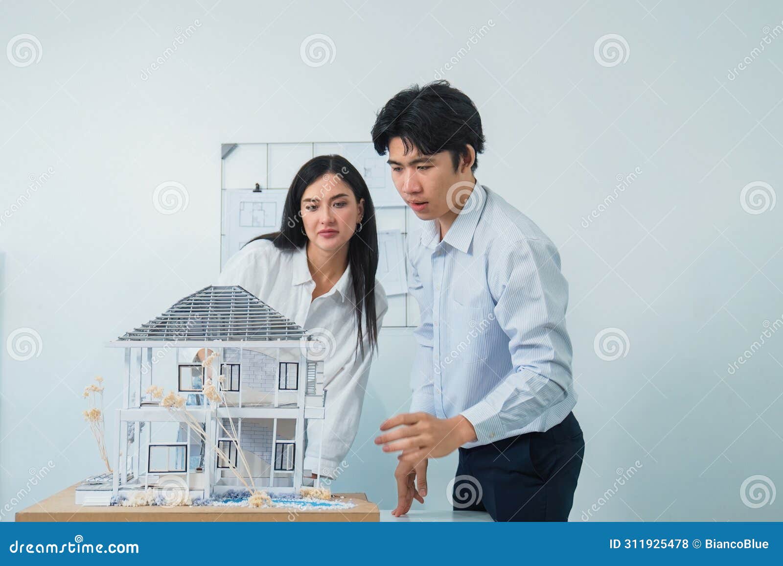 Cooperative Engineer Team Working Together To Measure House Model ...