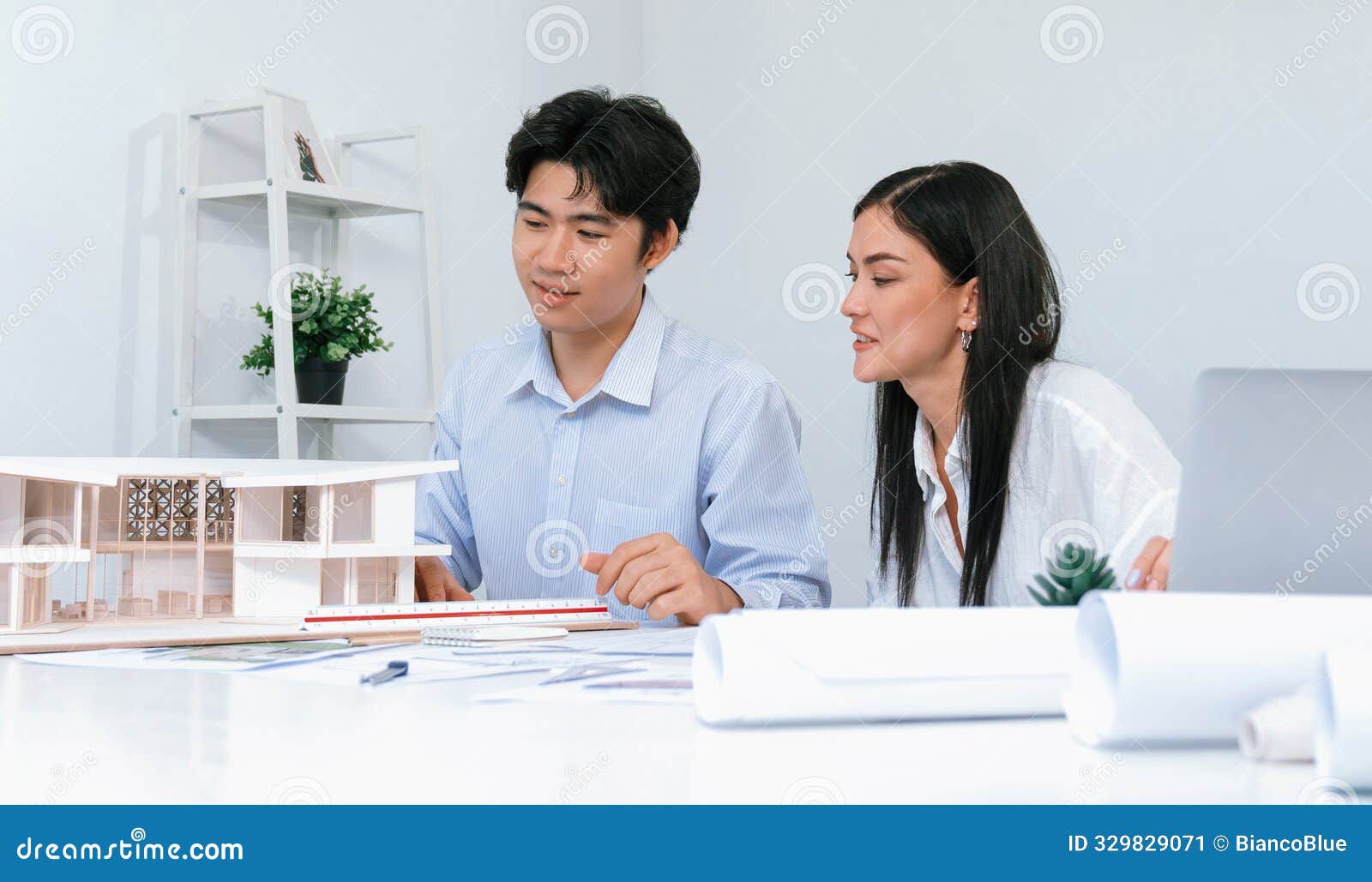 Cooperative Engineer Team Working Together To Measure House Model ...