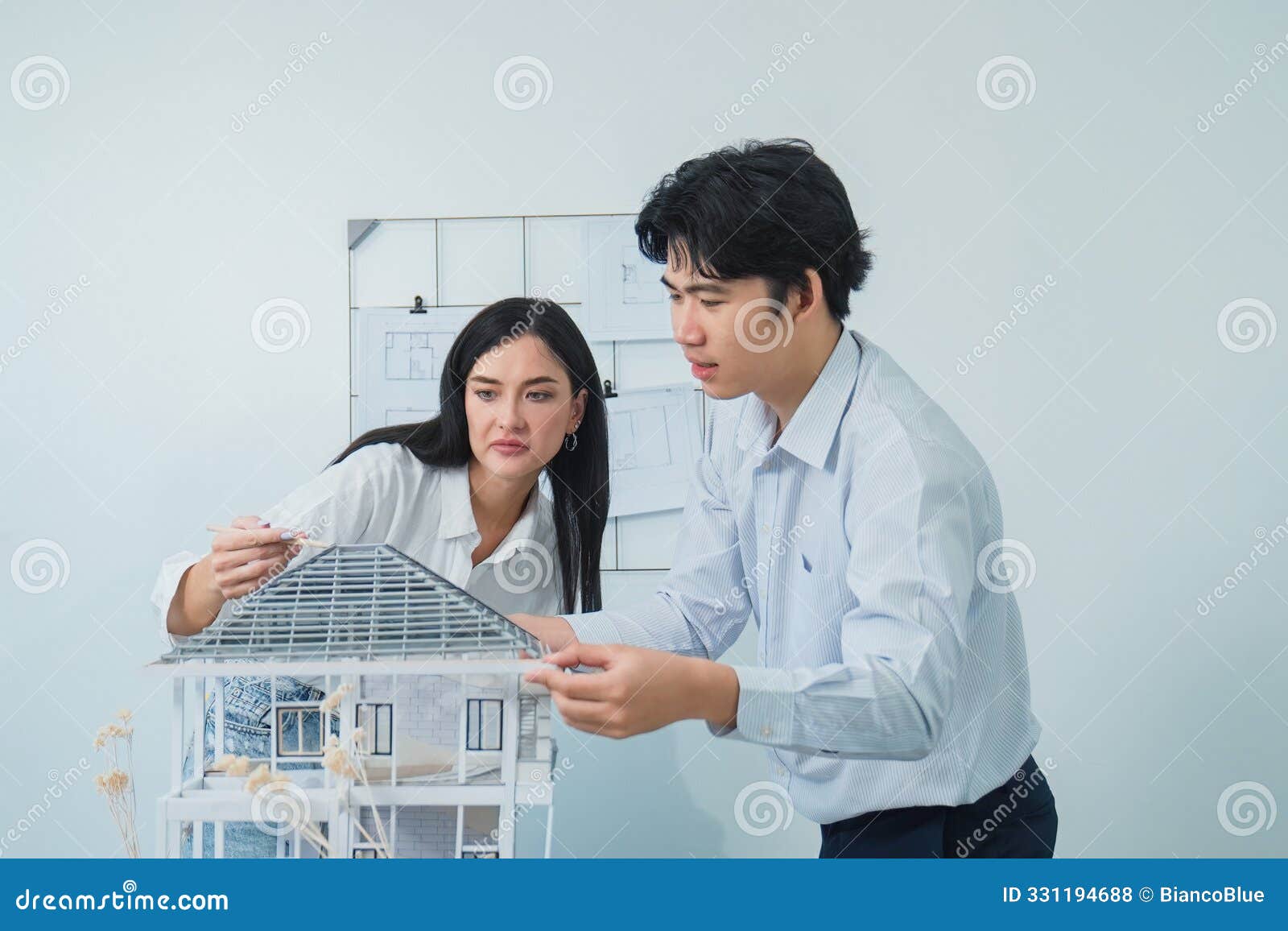 Cooperative Engineer Team Working Together To Measure House Model ...