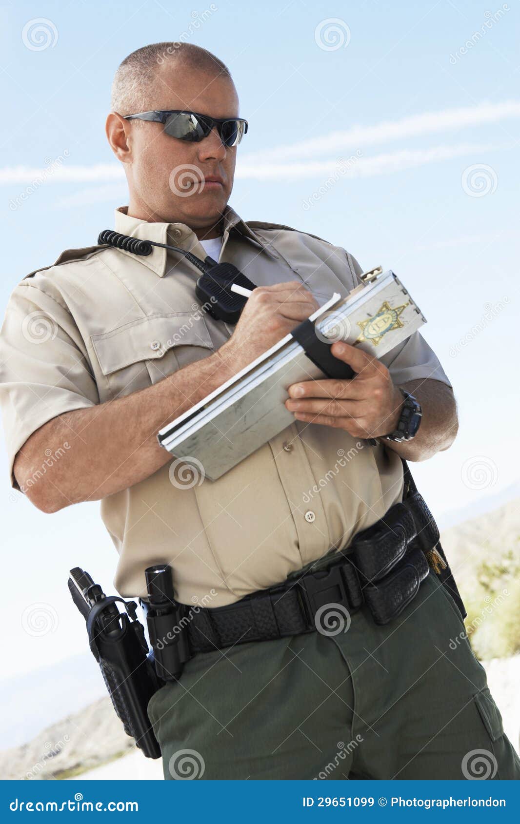 Cop Writing on Clipboard stock image. Image of control - 29651099