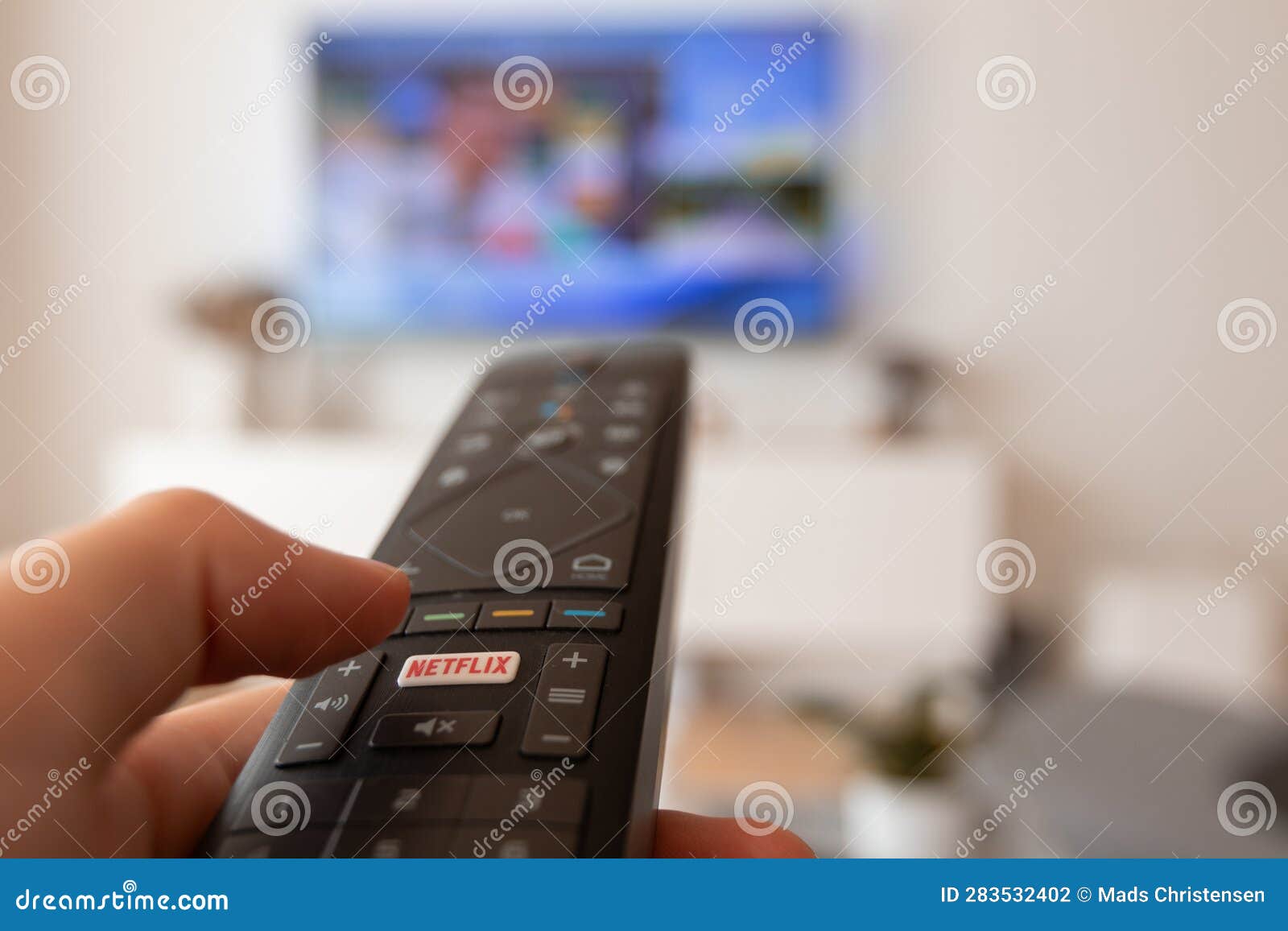 Copenhagen, Denmark, July 4th, 2023 - Hand Holding Remote, Pressing ...