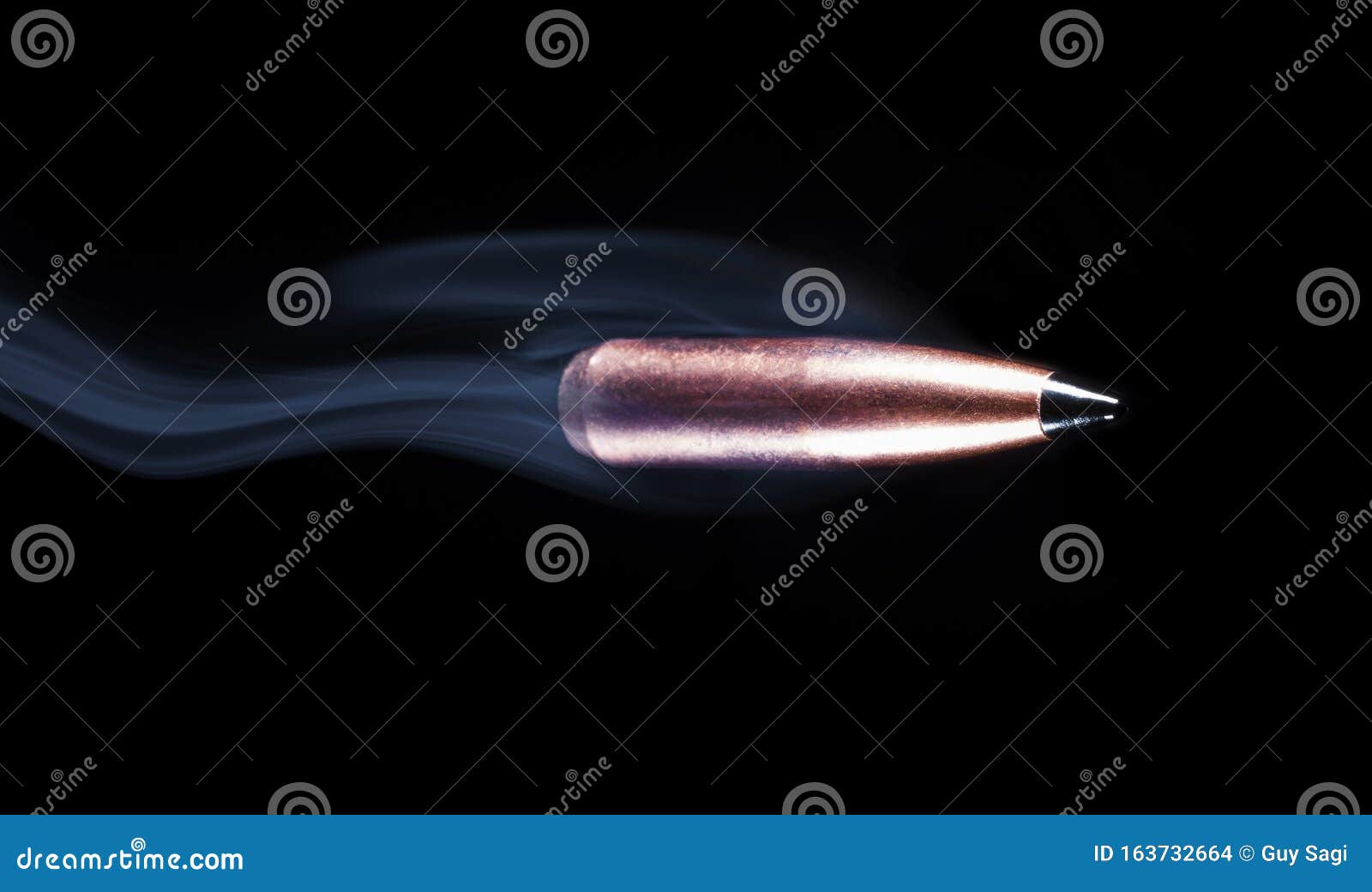 Bullet with Smoke Trailing Behind Stock Photo - Image of blue, black ...